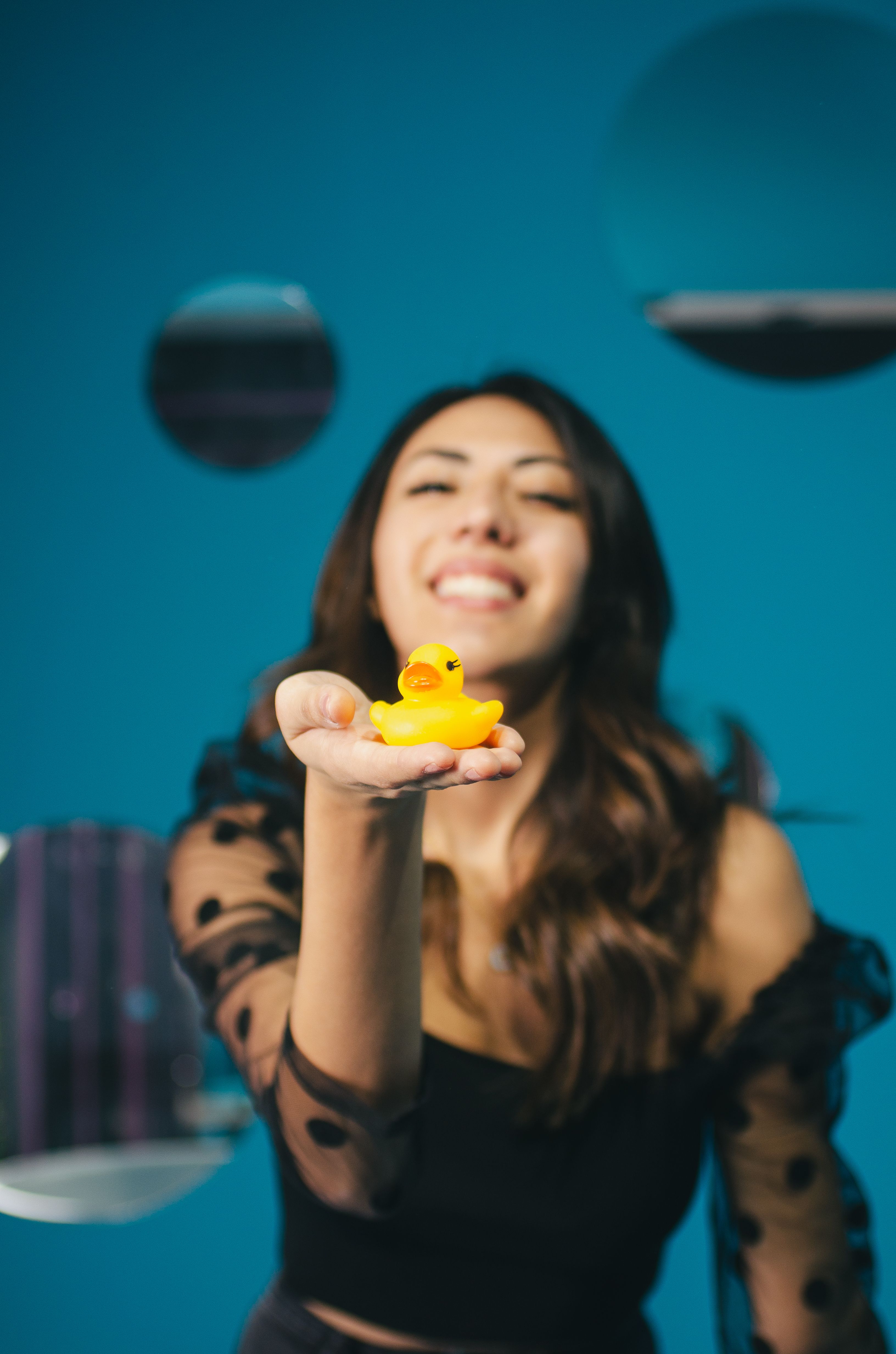 Long-Haired Brunette Holding a Rubber Duck · Free Stock Photo