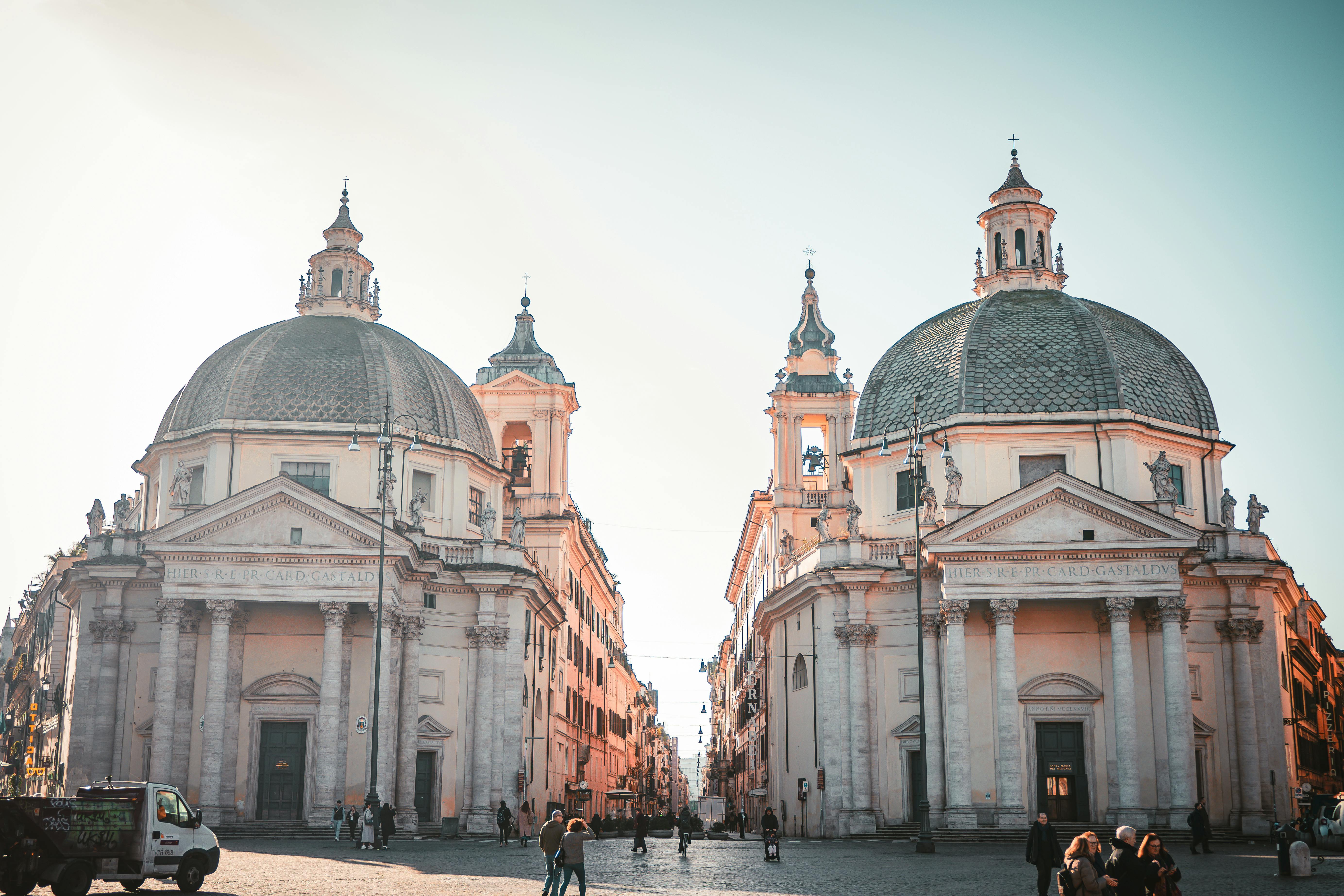 Two buildings with domes in the middle of a city · Free Stock Photo