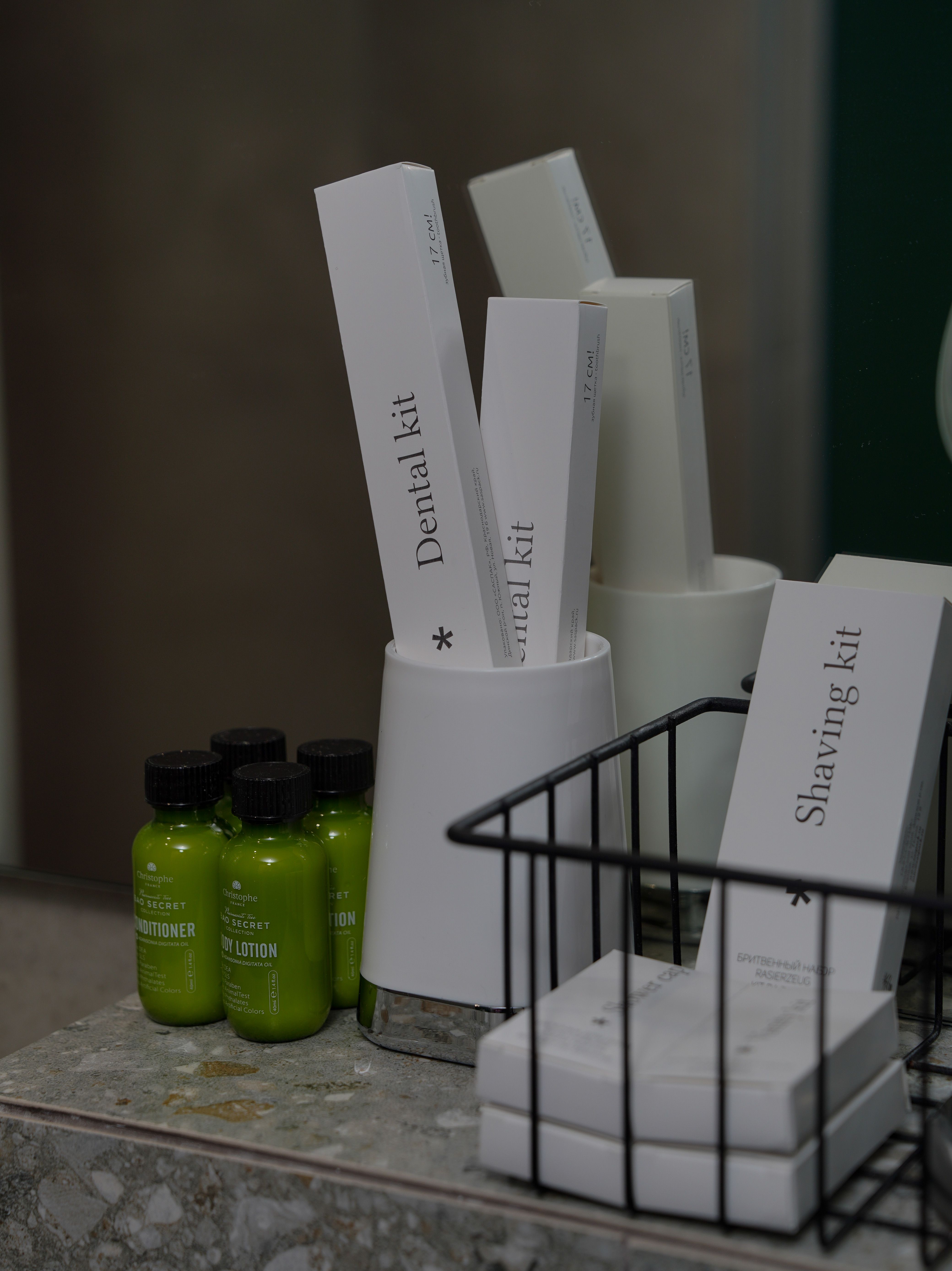 Boxes of Toiletries and Lotion Bottles in Hotel Bathroom · Free Stock Photo