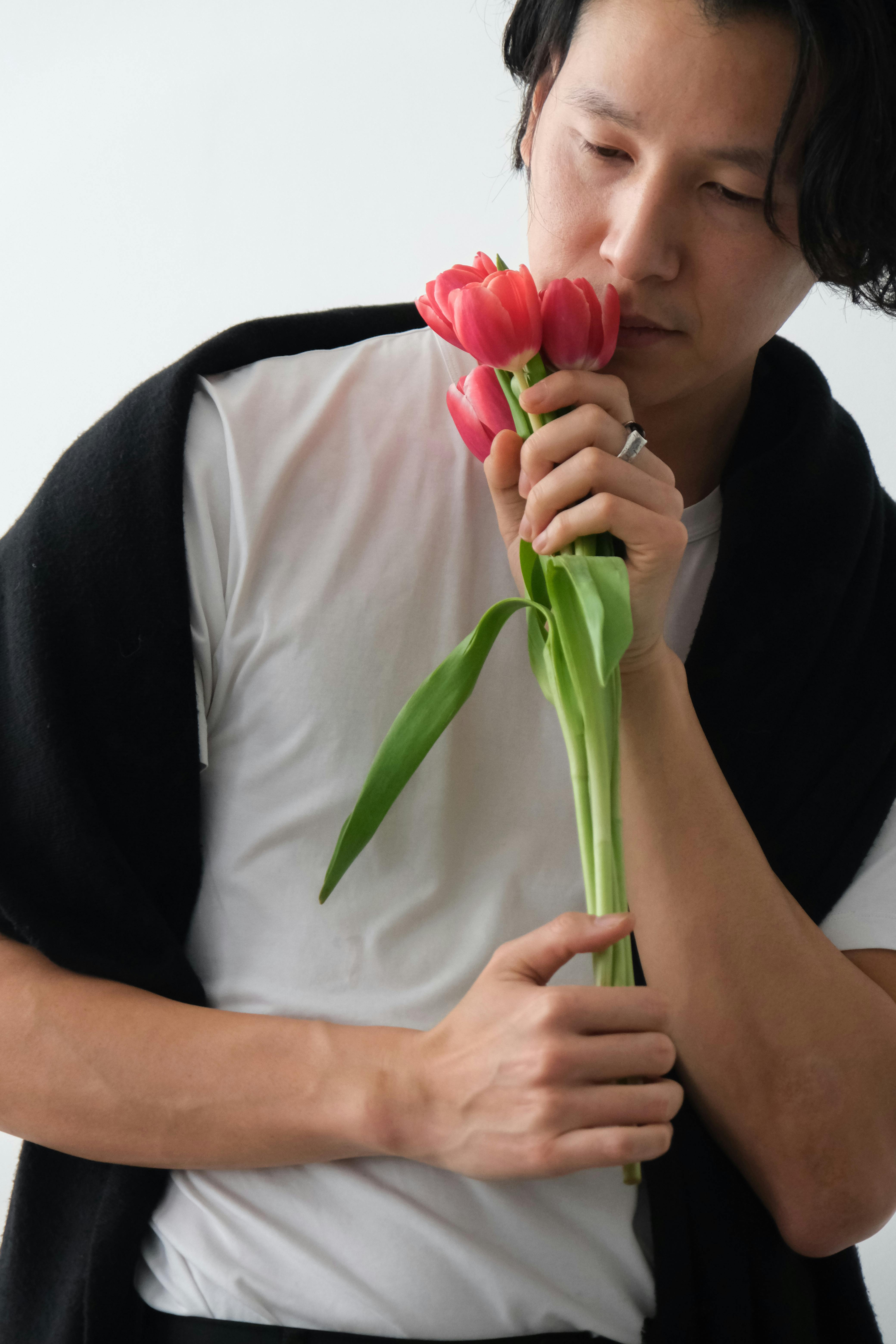 Portrait of Man Smelling Flowers · Free Stock Photo