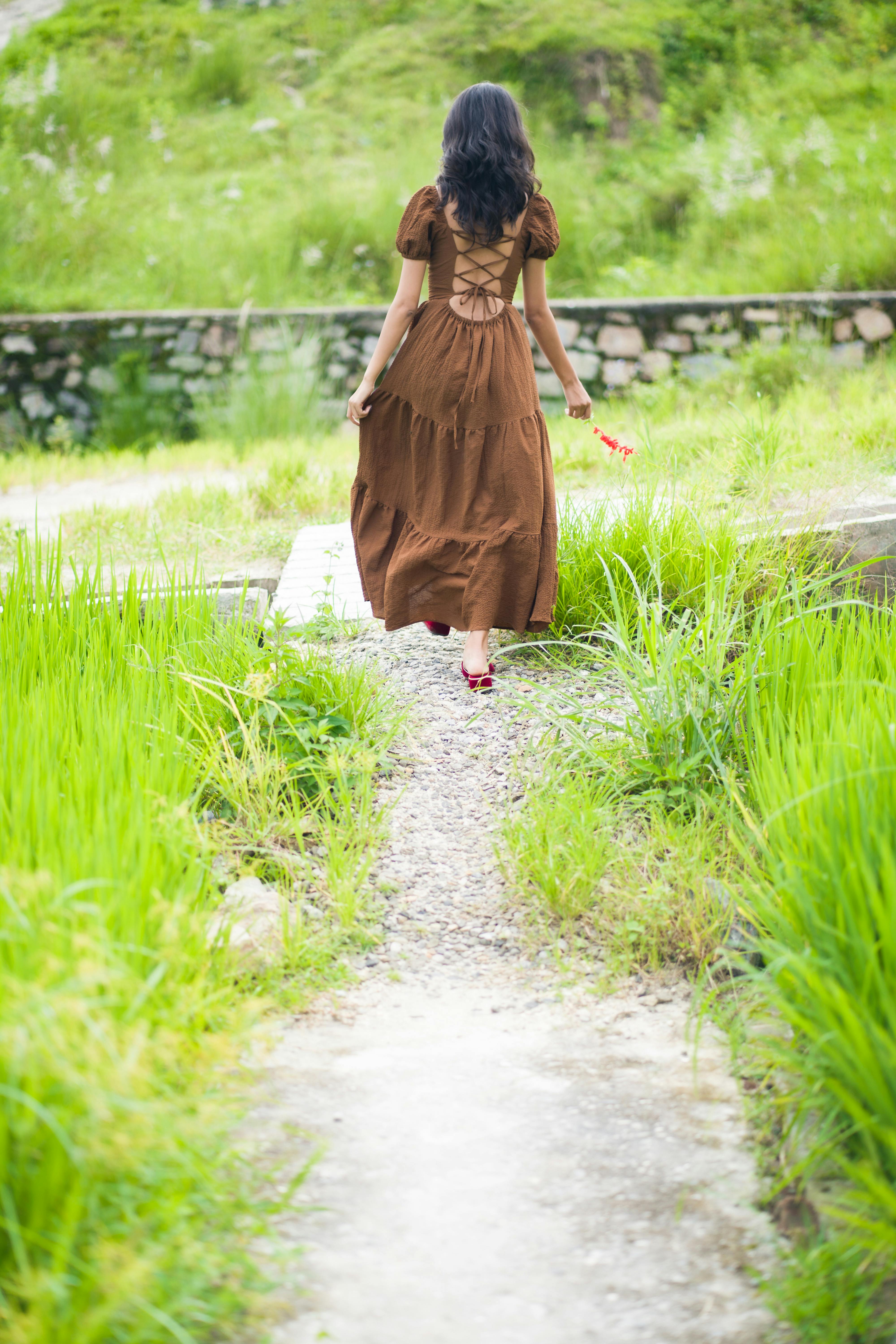 Back View of Woman in Dress Walking on Footpath in Countryside · Free ...