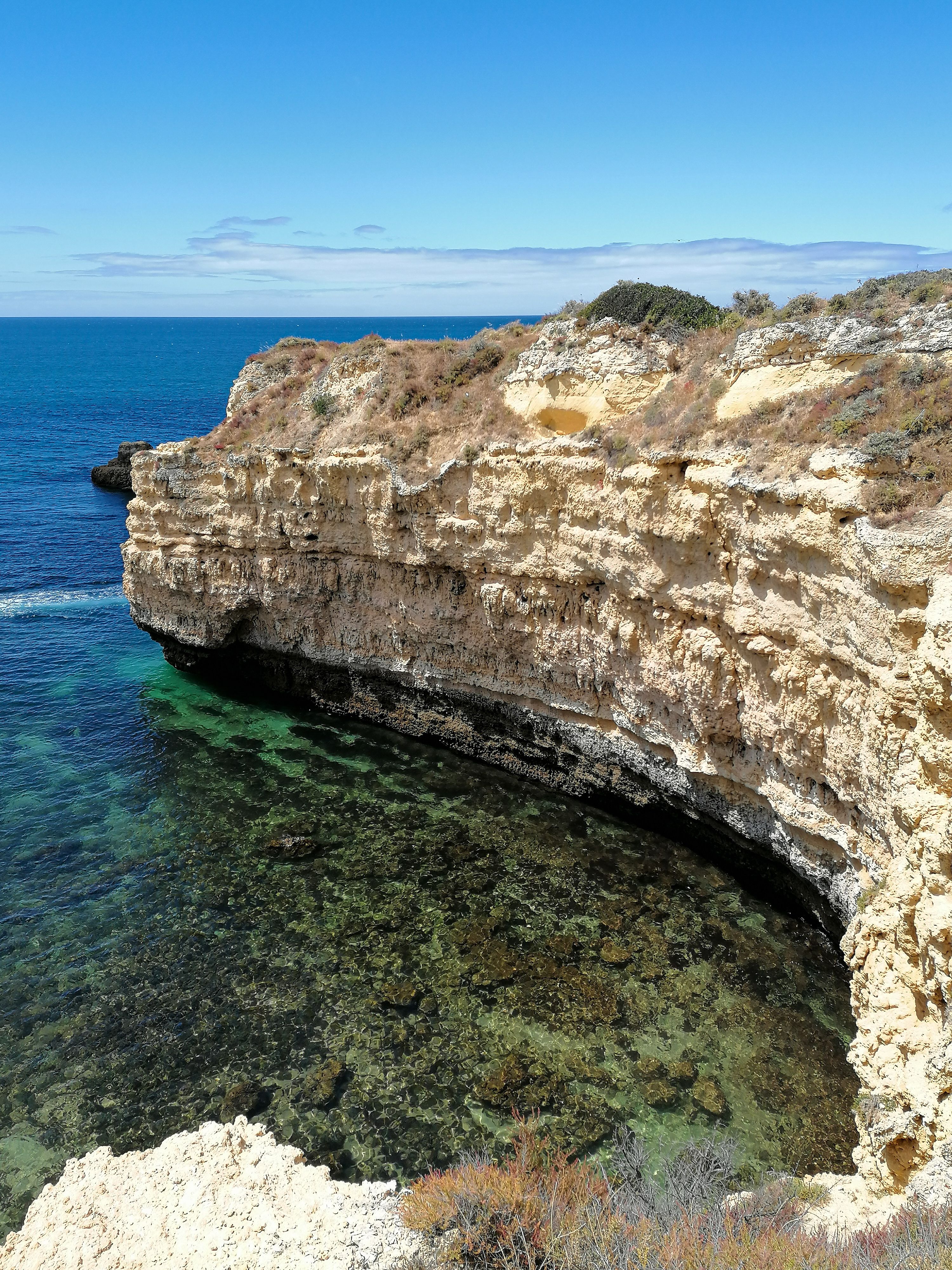 Rocky Cliff over Sea in a Bay · Free Stock Photo