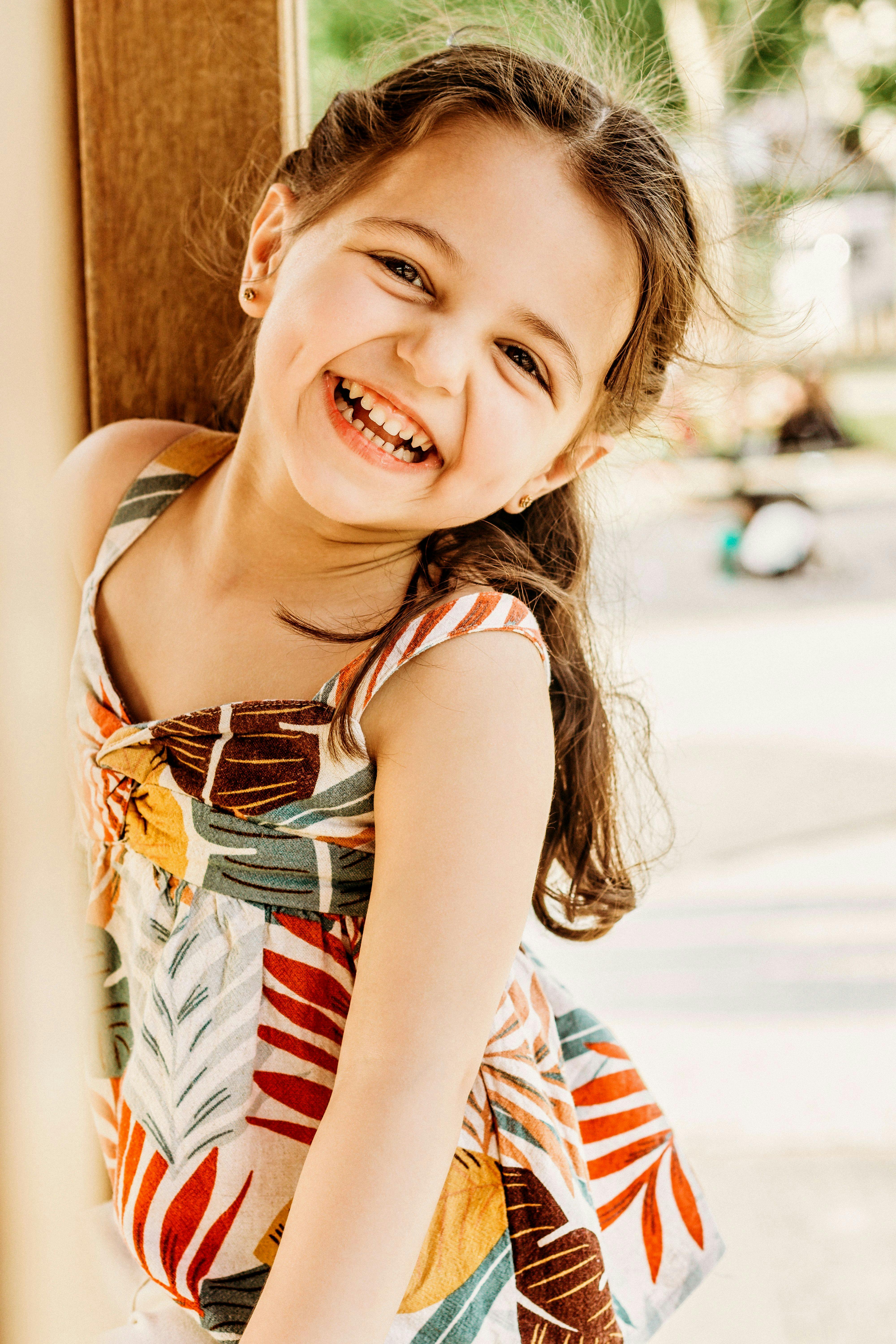 Child Standing in Door Laughing and Smiling · Free Stock Photo