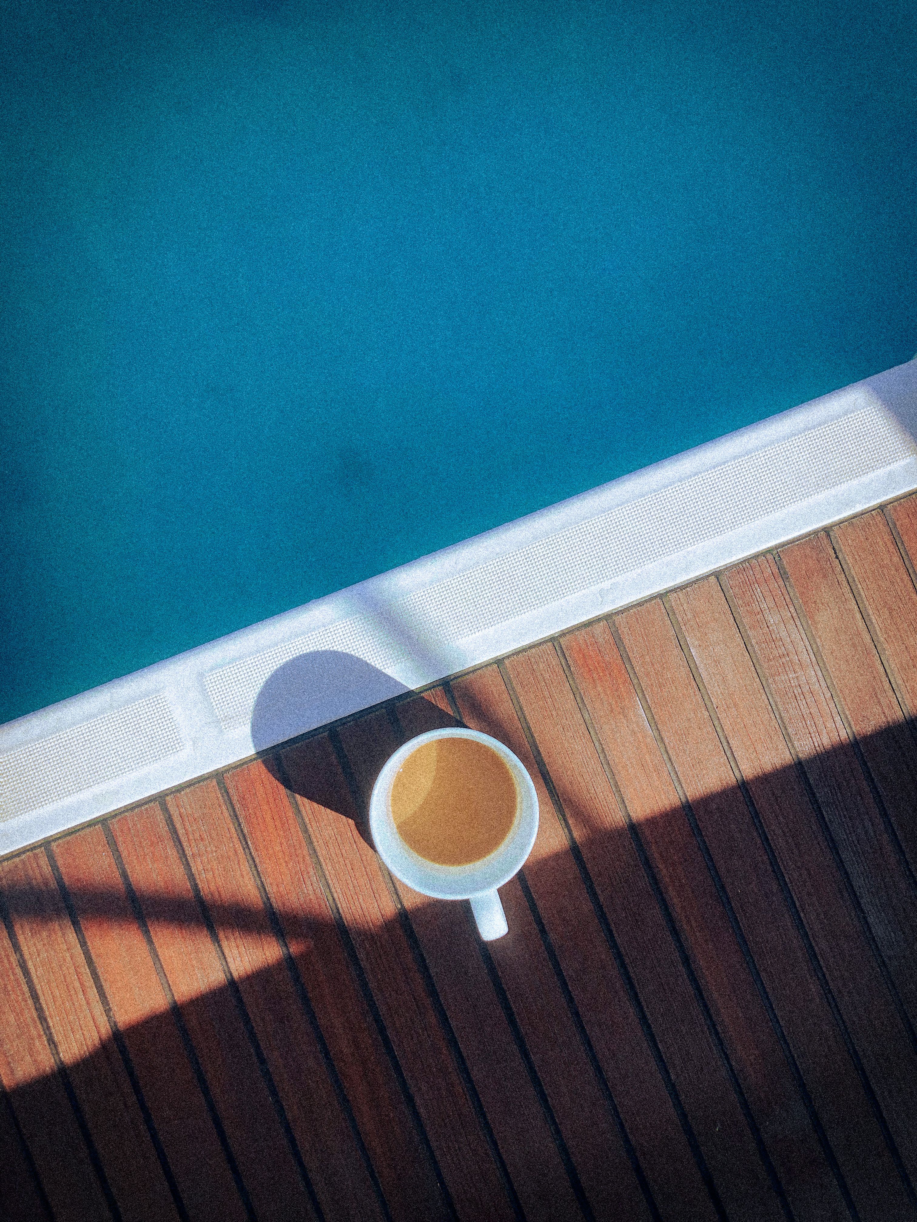 Mug of Coffee by Swimming Pool · Free Stock Photo