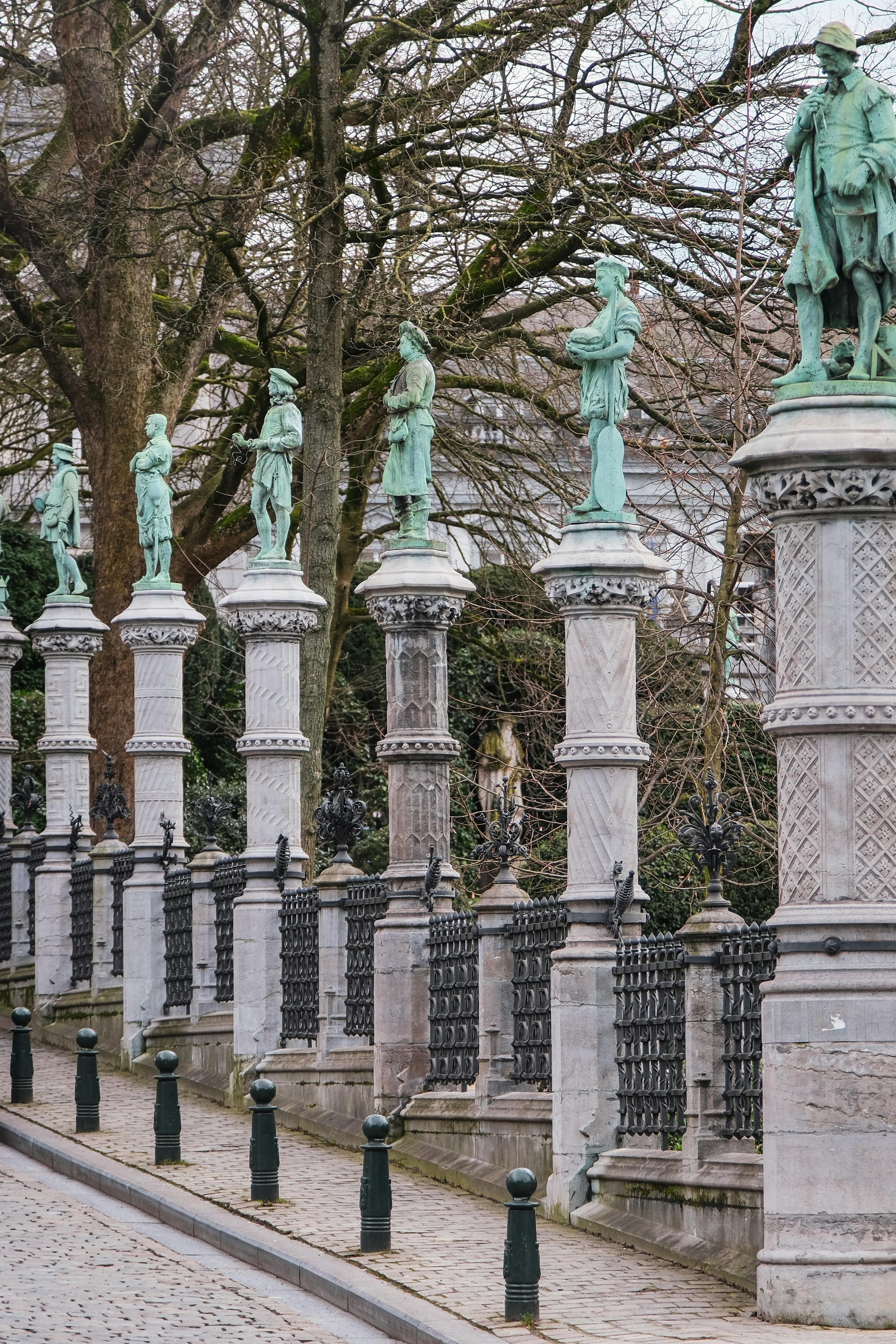 Row of Statues on Pedestals by Street · Free Stock Photo