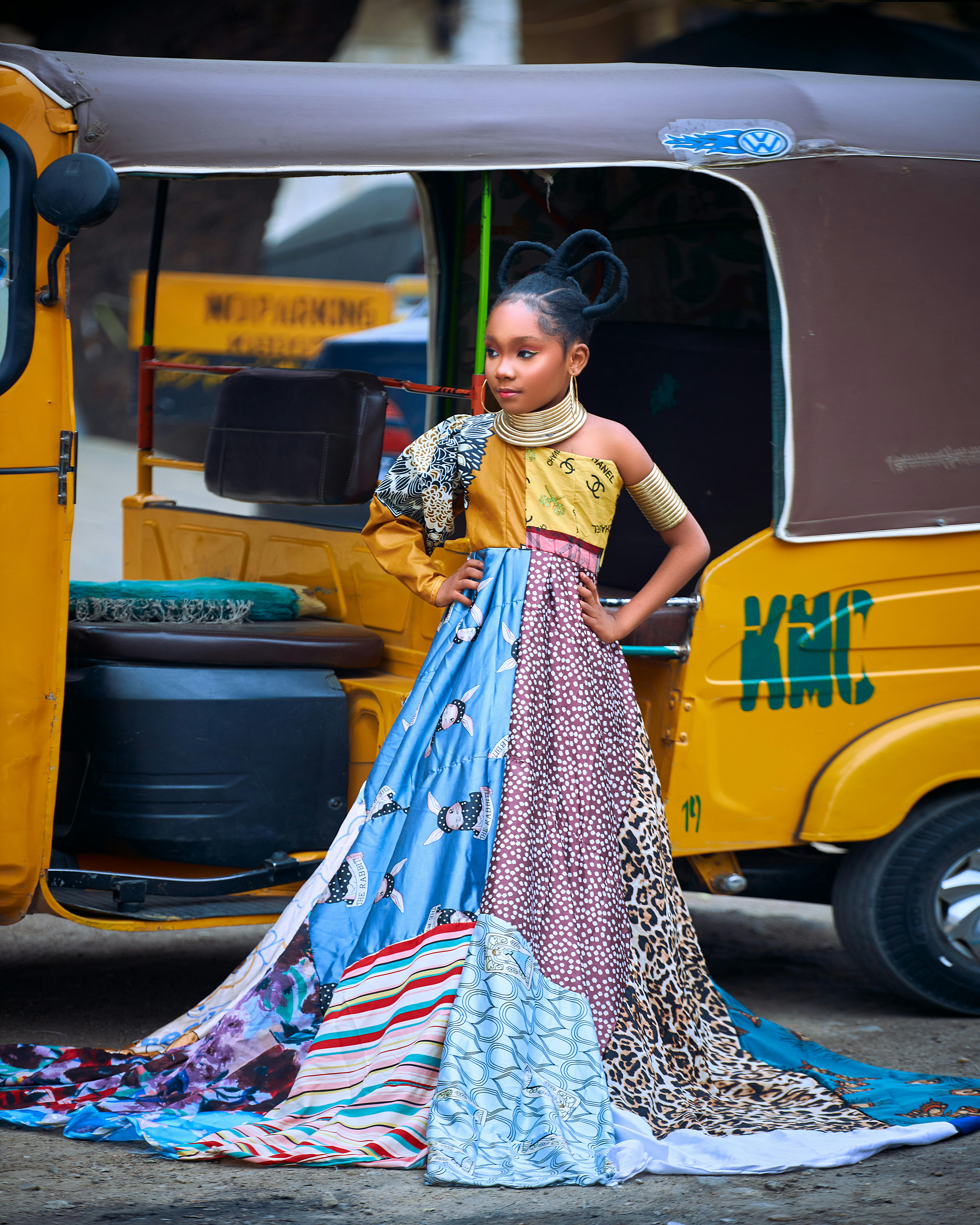Child Model in Patchwork Dress Posing by Rickshaw · Free Stock Photo