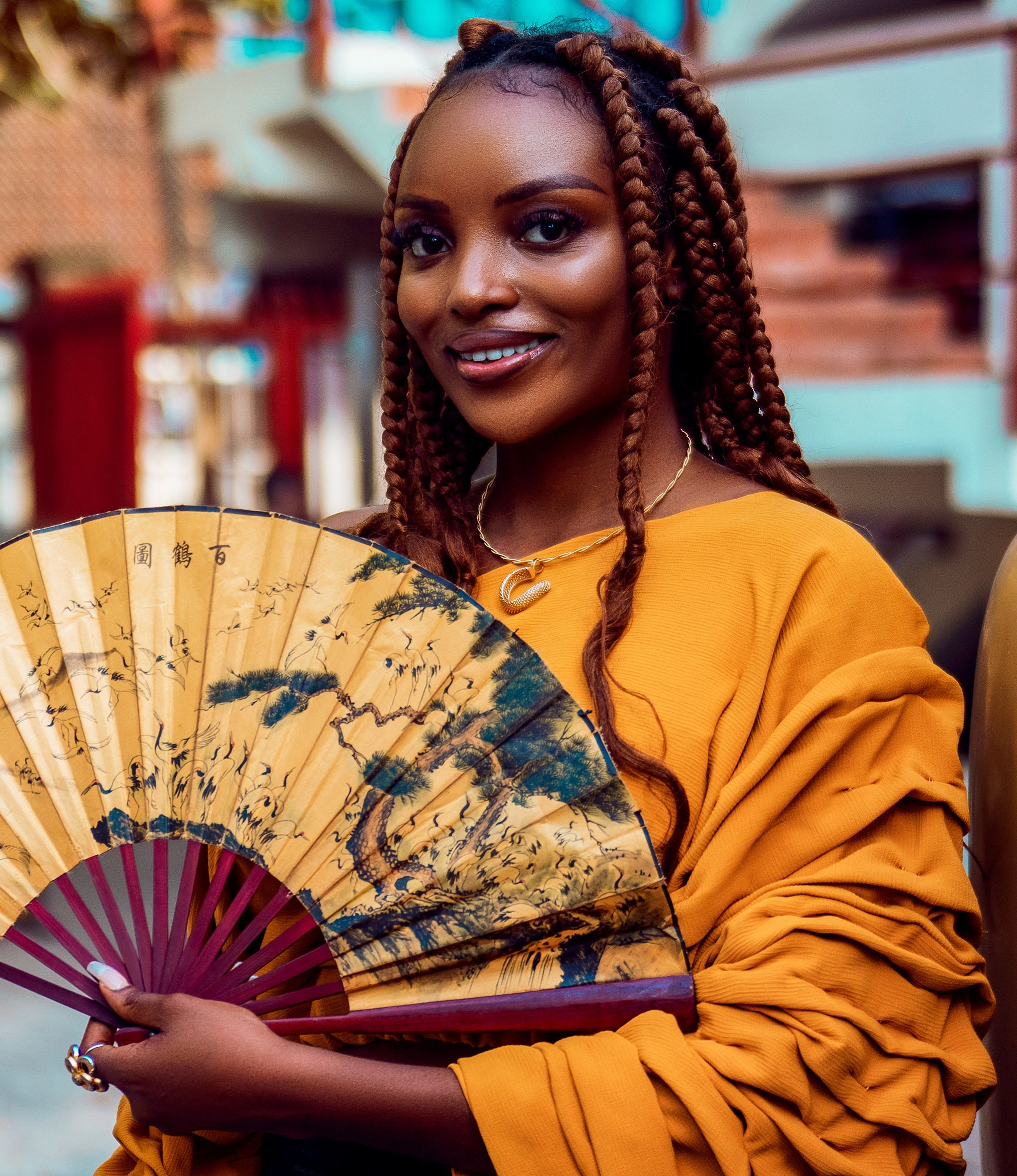 A woman holding a fan in her hand · Free Stock Photo