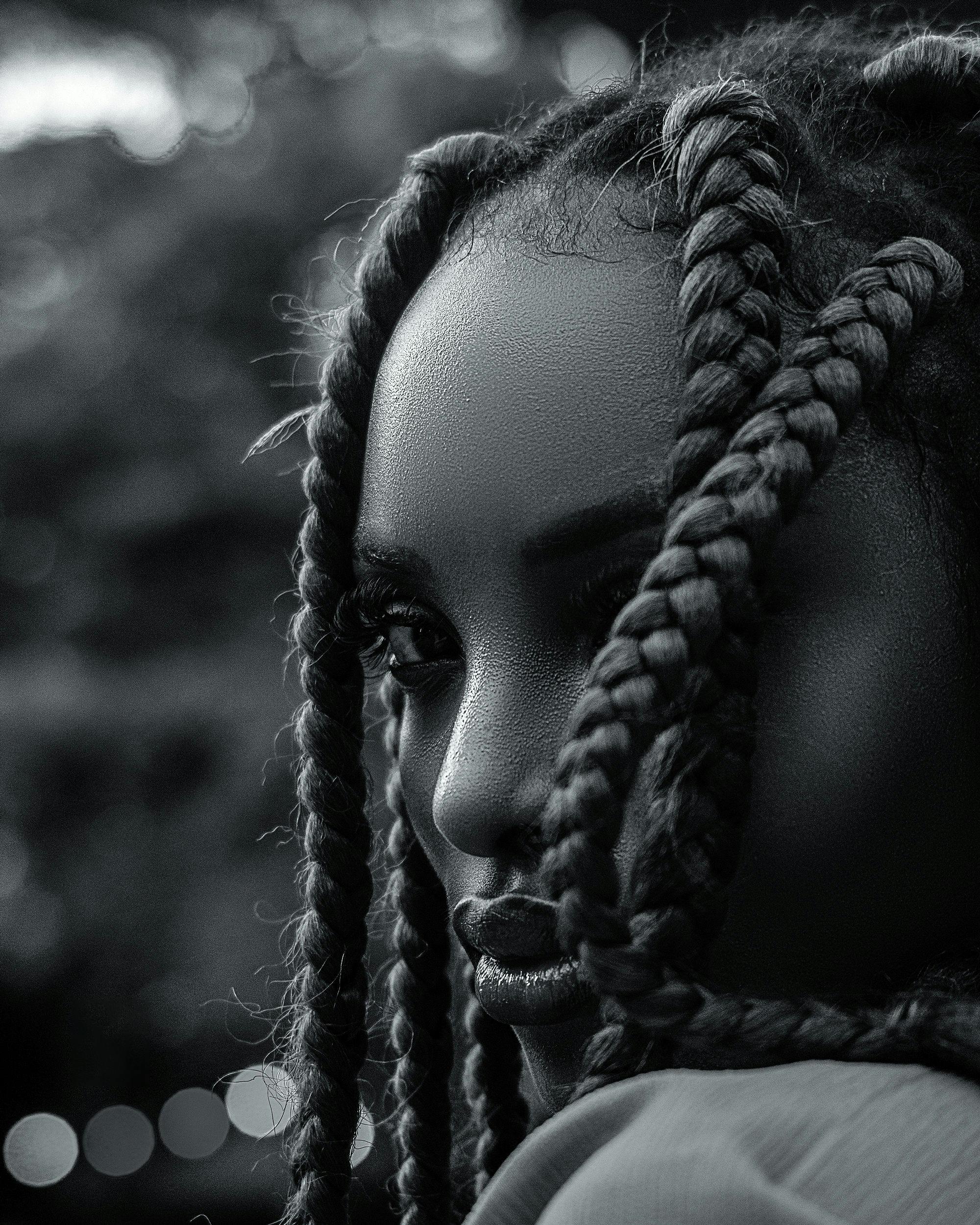 A black and white photo of a woman with braids · Free Stock Photo