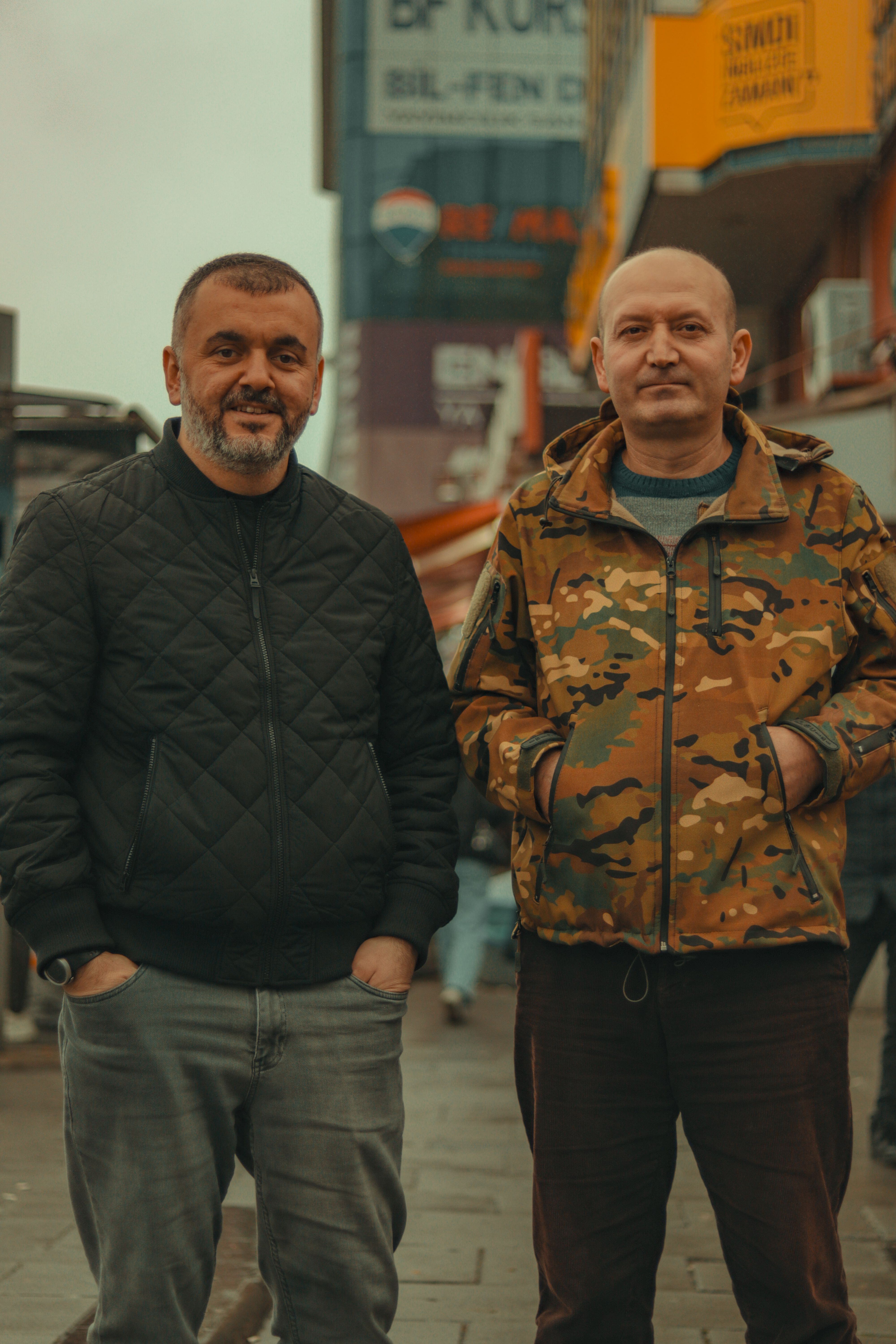 Two Men Standing Side by Side with Hands in Pockets · Free Stock Photo