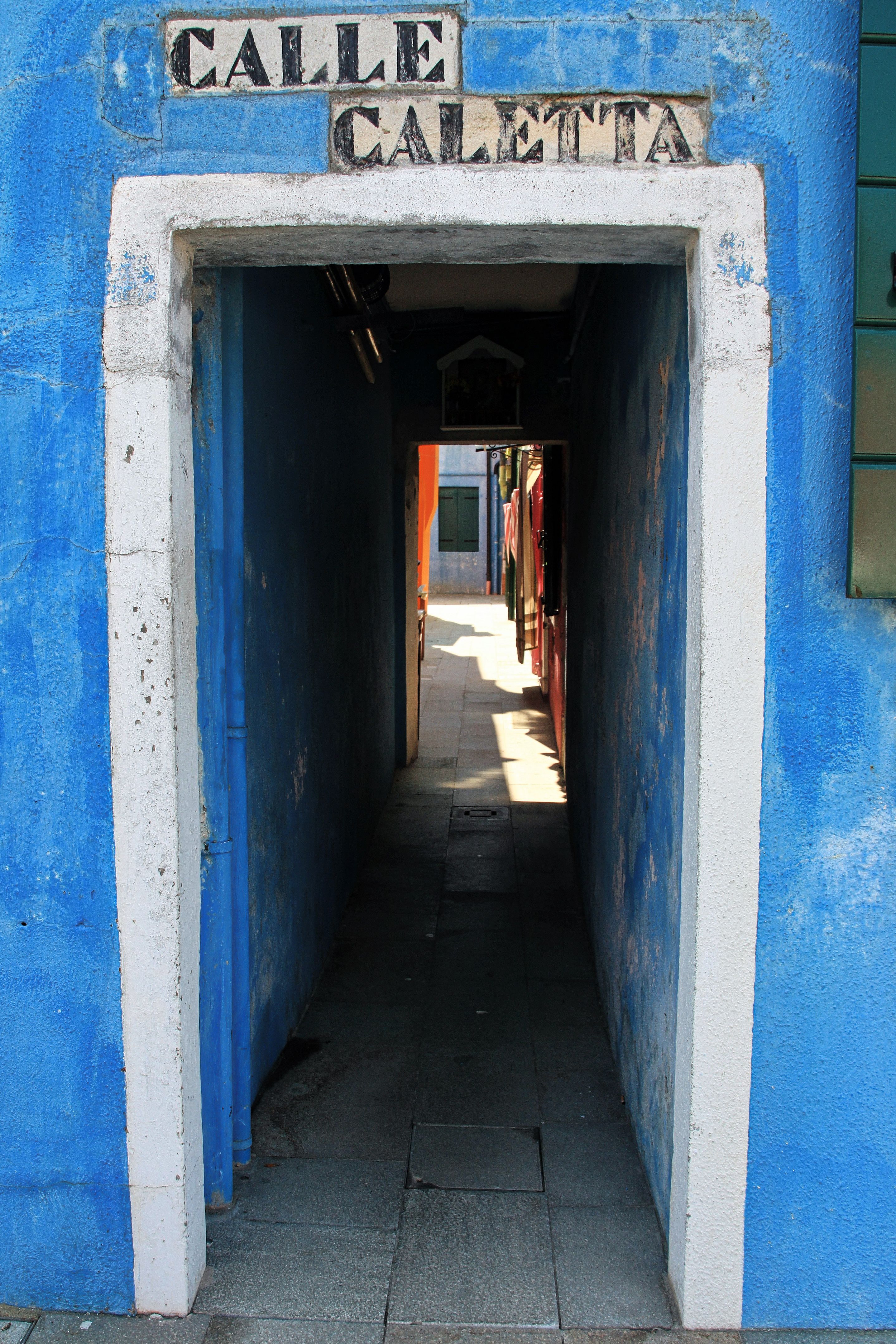 Inscription over Narrow Street Tunnel · Free Stock Photo