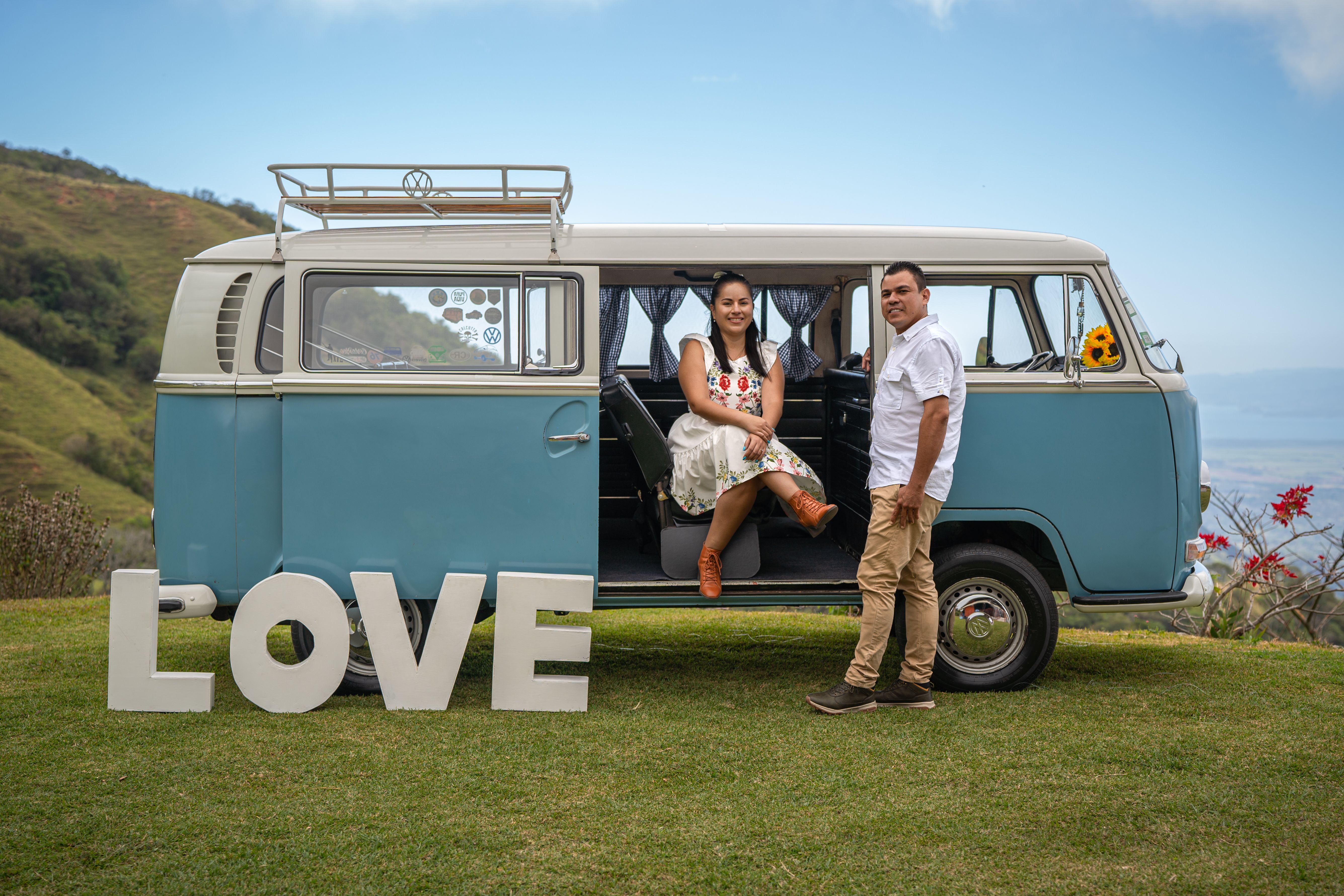A Woman Sitting in a Van and a Man Standing next to Her · Free Stock Photo