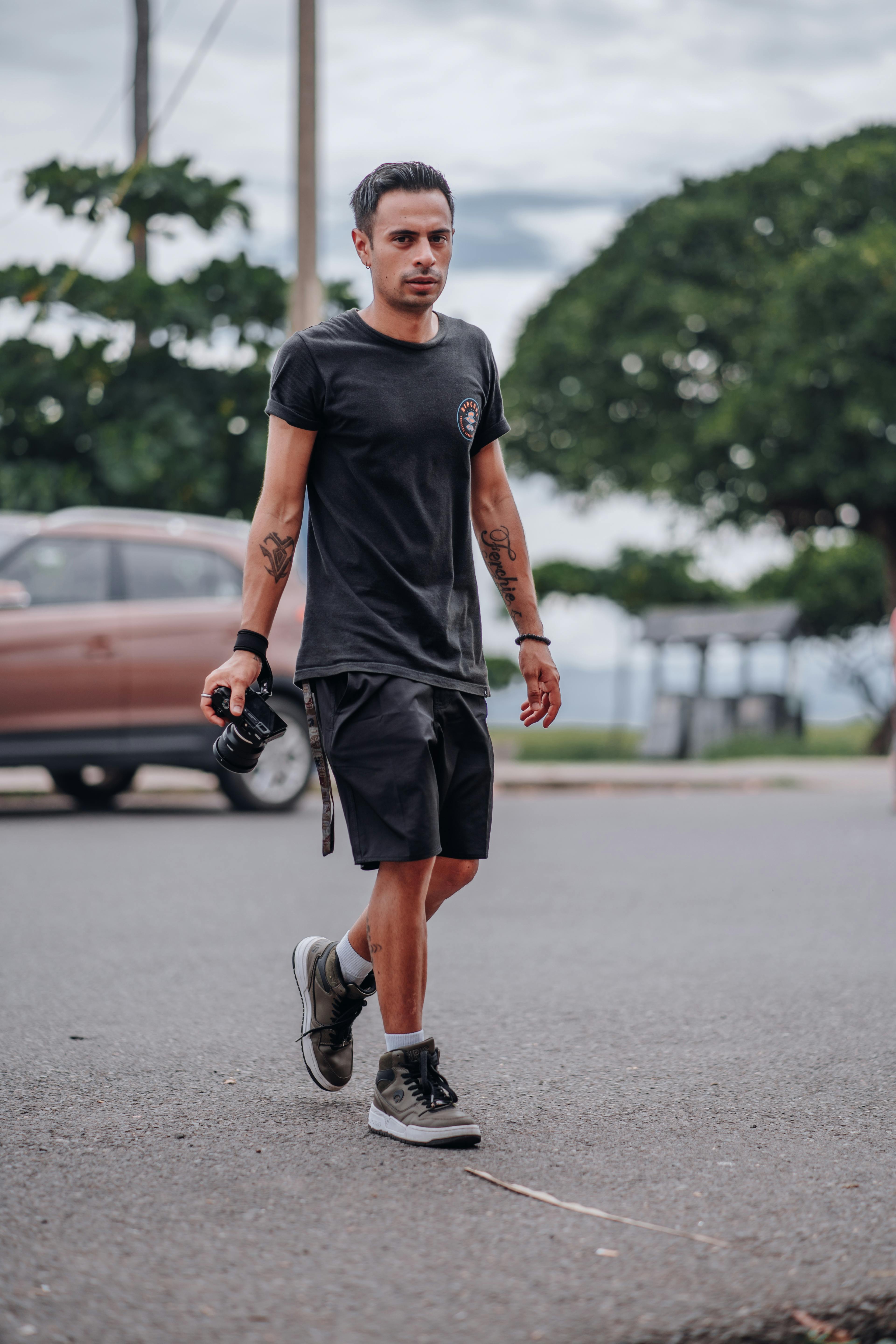 Man Walking with Camera on Street · Free Stock Photo