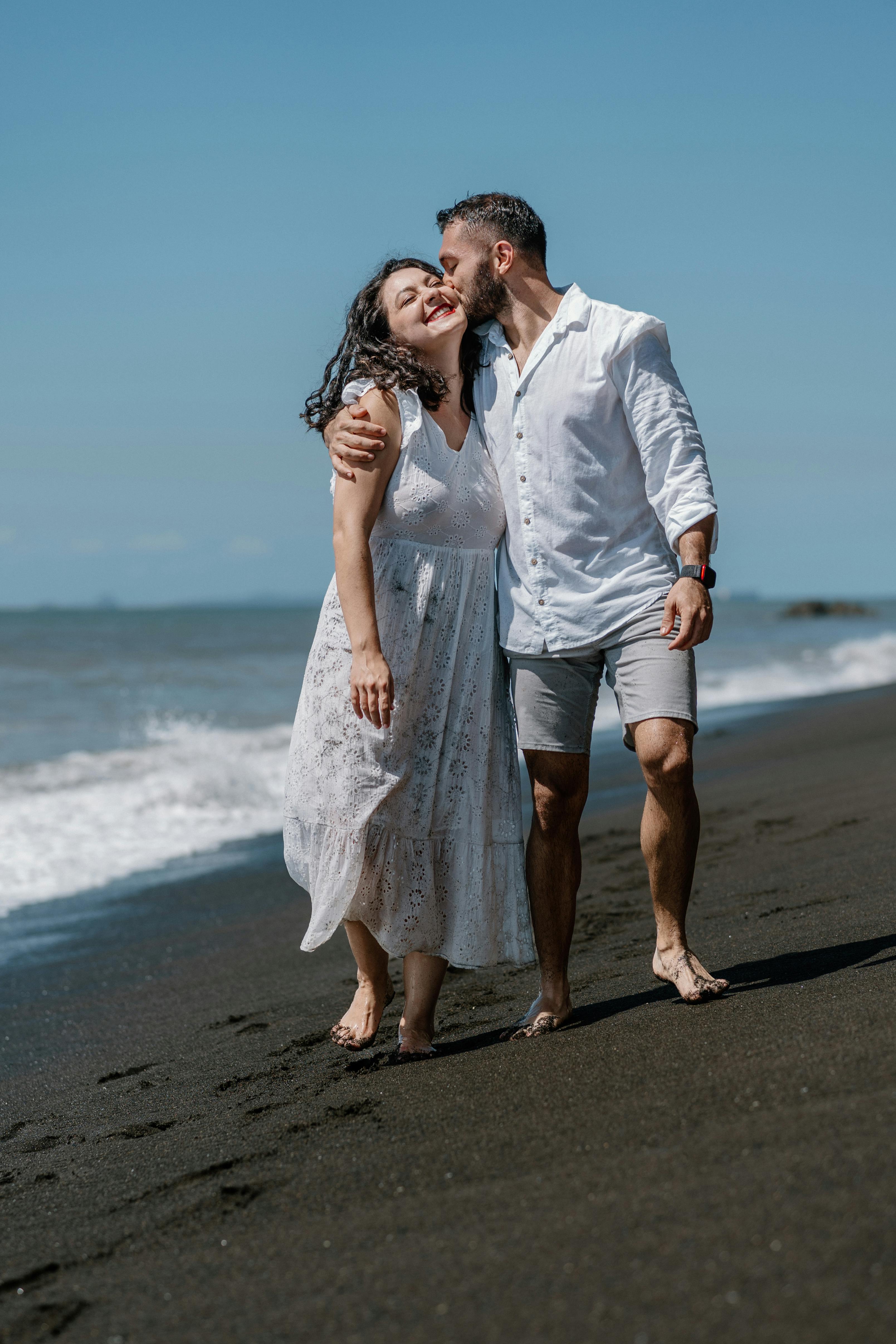Couple Kissing on a Sandy Beach · Free Stock Photo