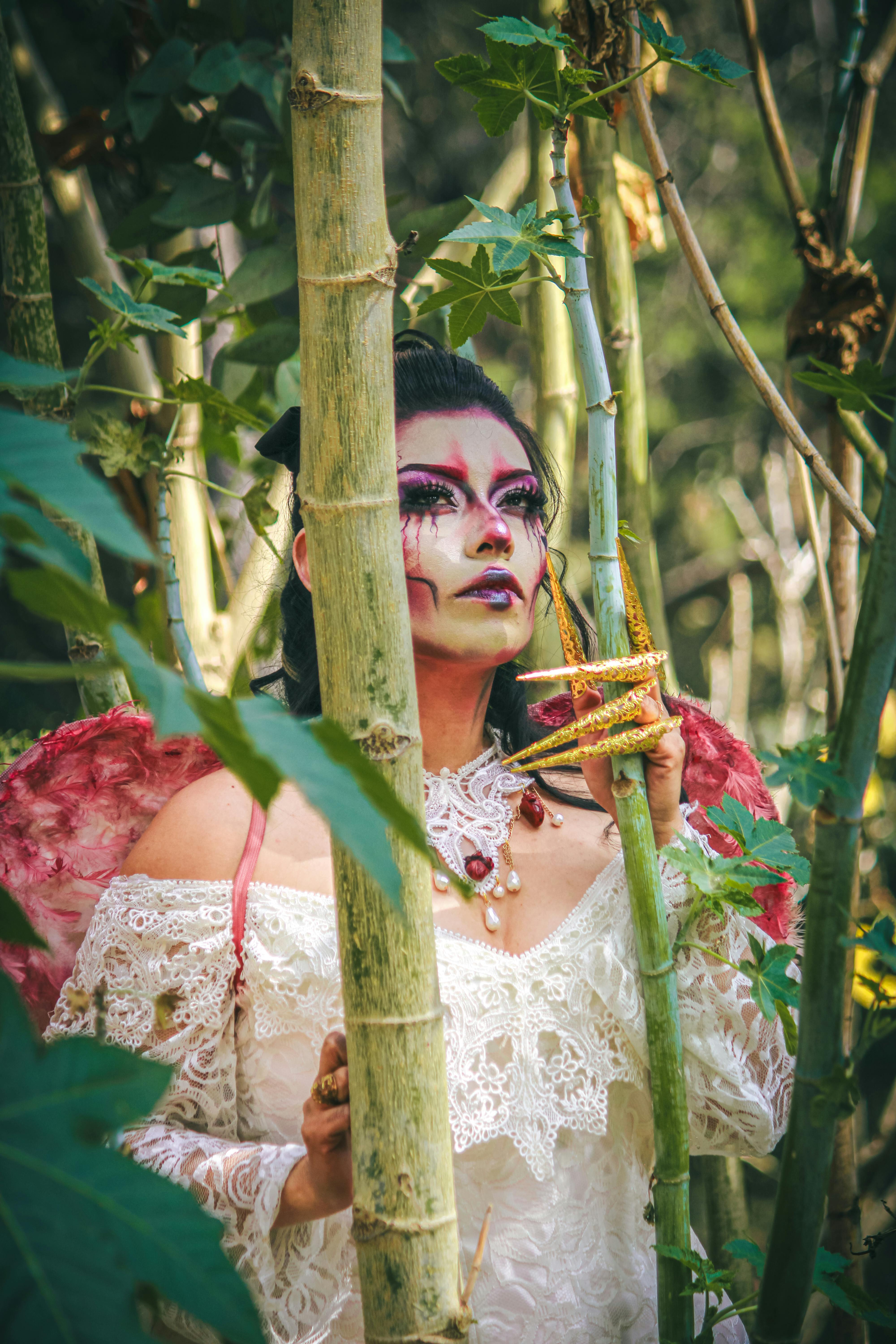 Woman in Cosplay Costume among Bamboo Trees · Free Stock Photo