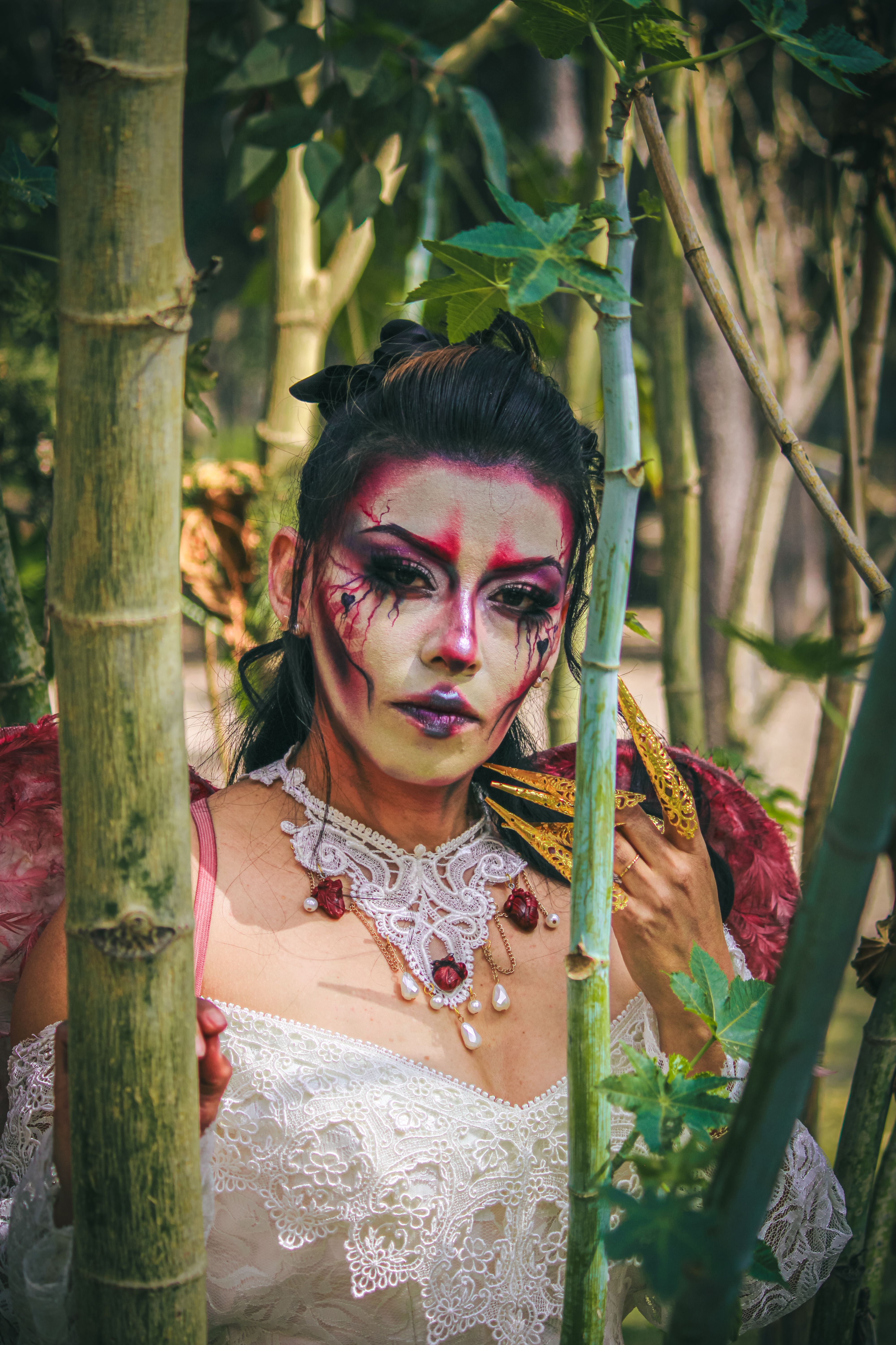 Woman in Cosplay Costume among Bamboo Trees · Free Stock Photo