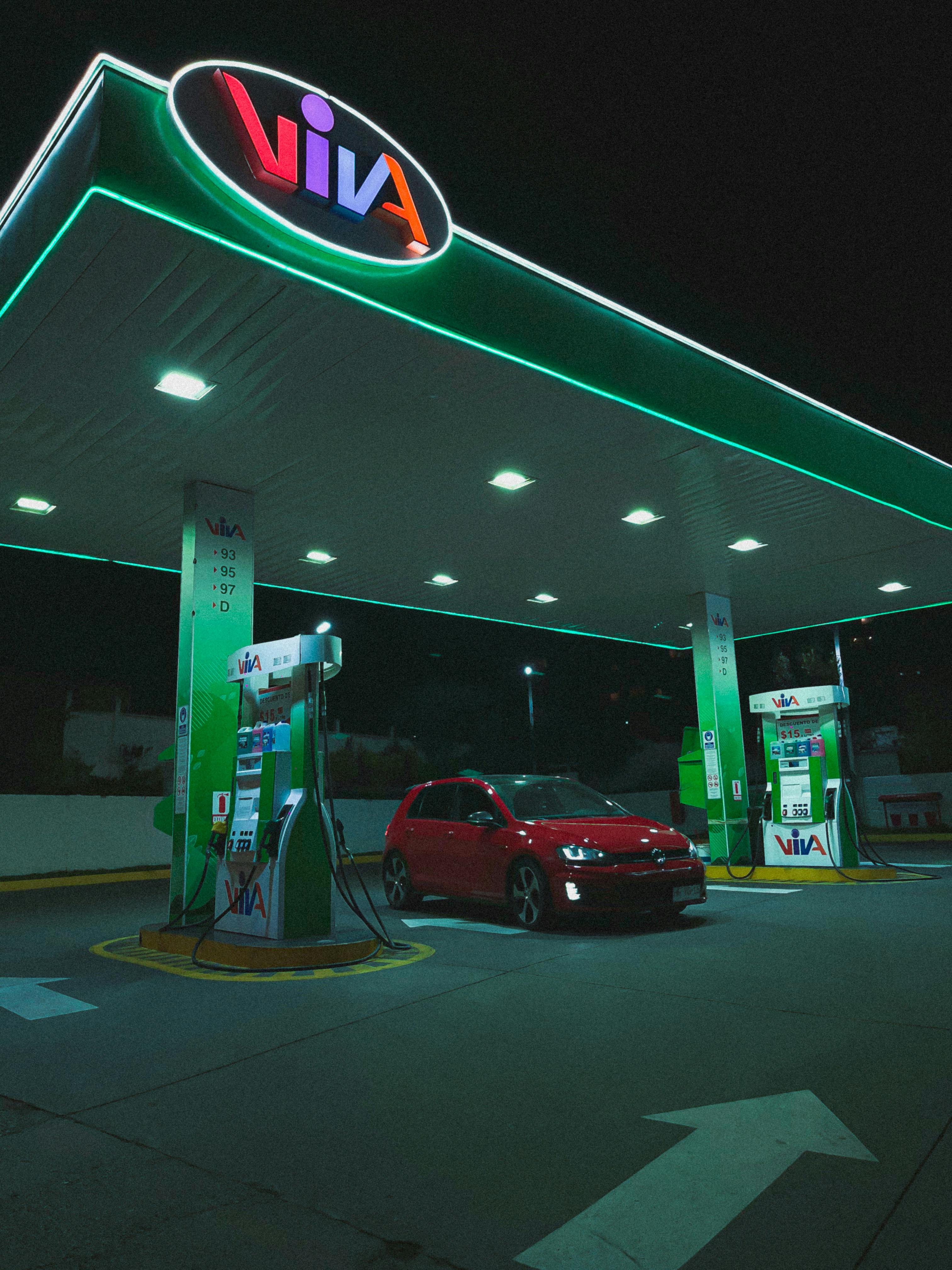 Man Standing next to a car at Gas Station · Free Stock Photo