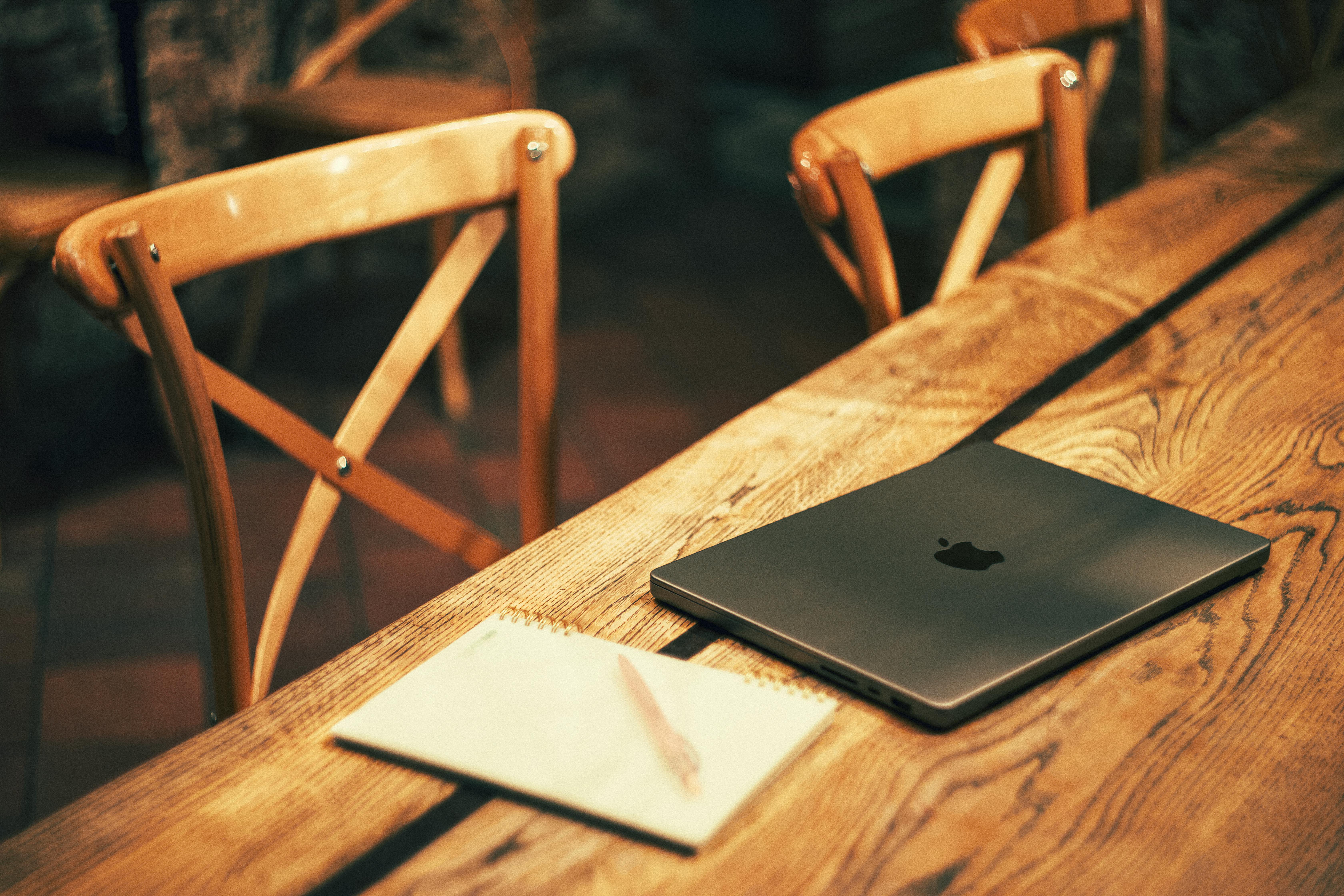 Pear Fruit Beside a Spiral Notebook and Laptop on Yellow background ...