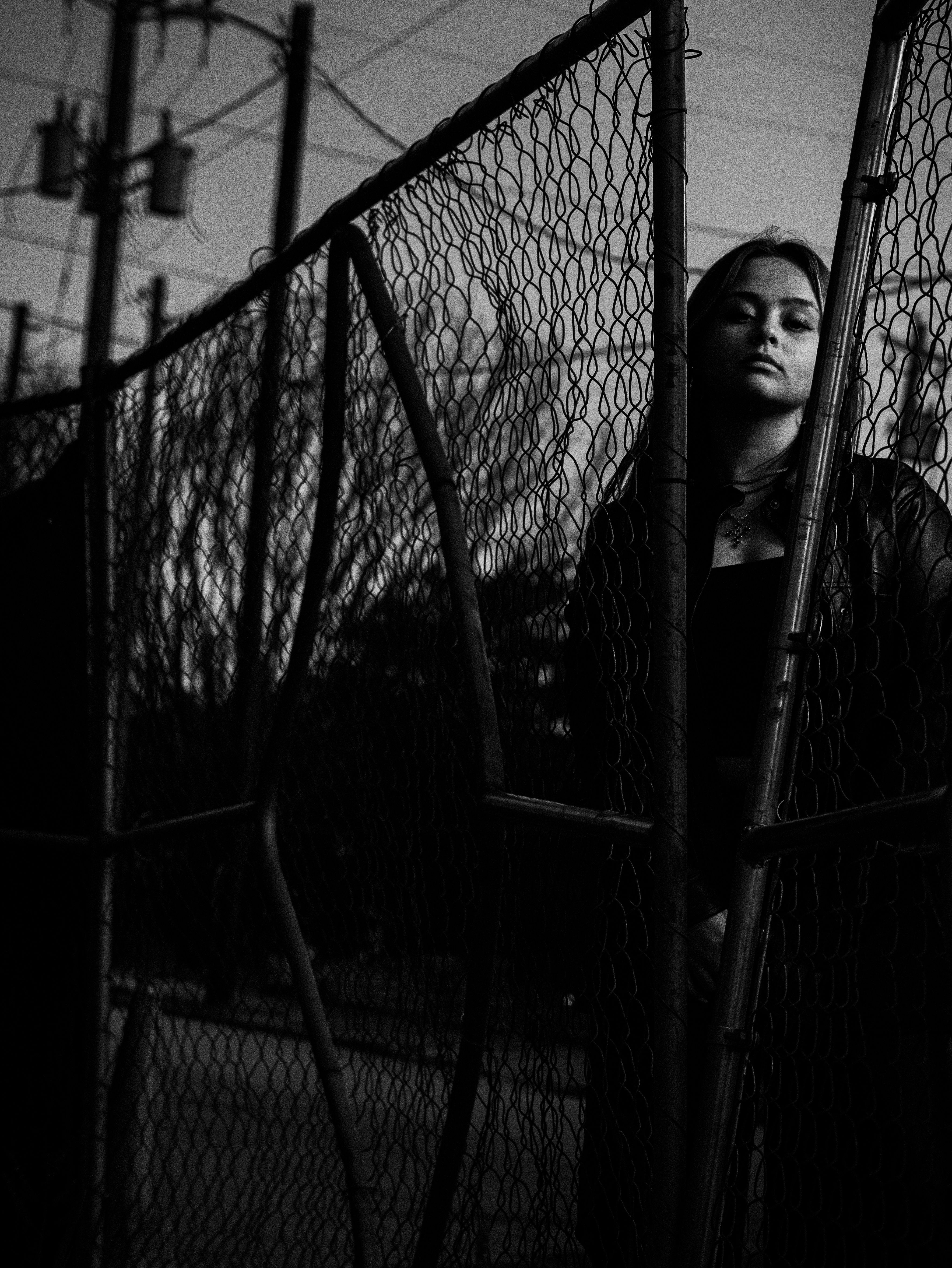Young Woman Standing behind the Fence · Free Stock Photo
