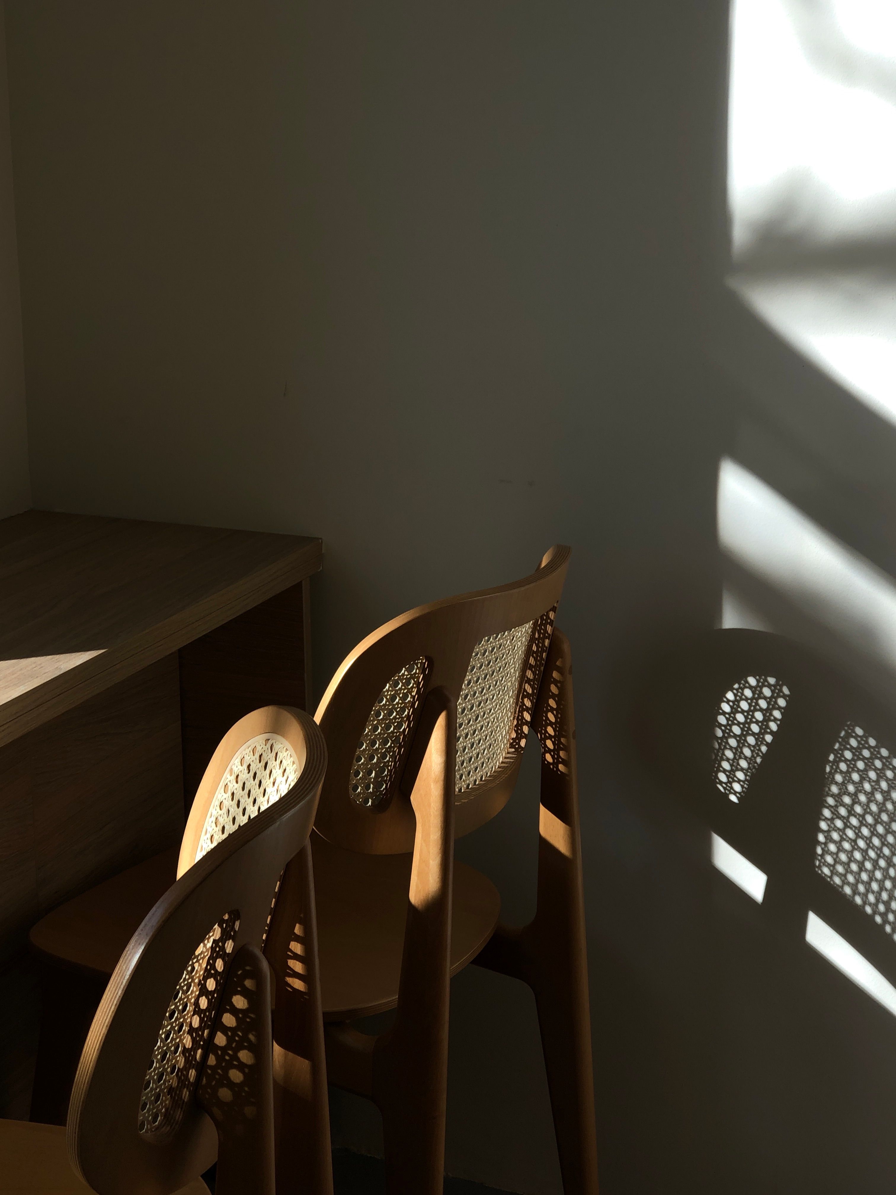 Chairs Casting Shadows on Wall · Free Stock Photo