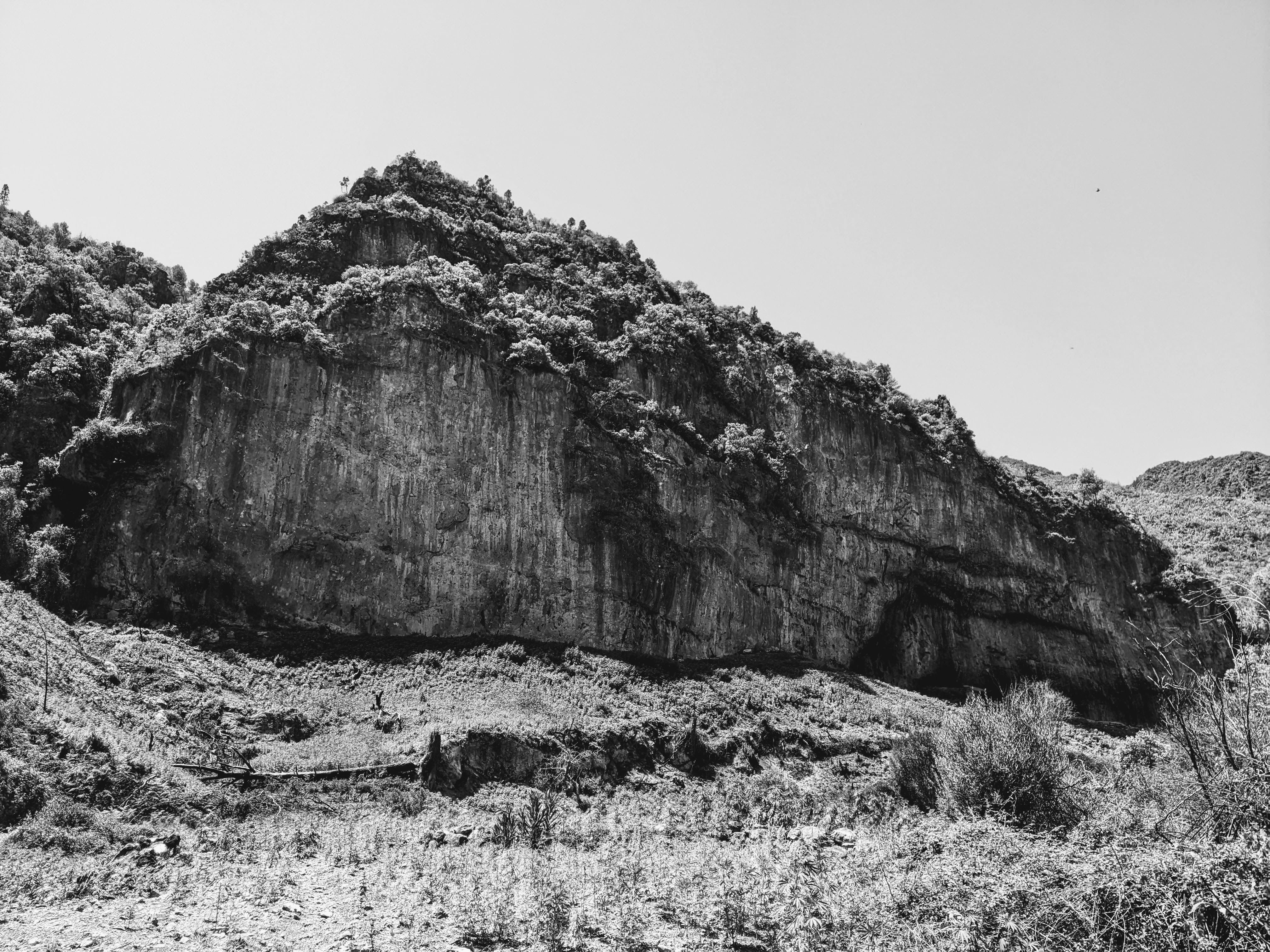 Black and White Photo of a Rocky Cliff · Free Stock Photo