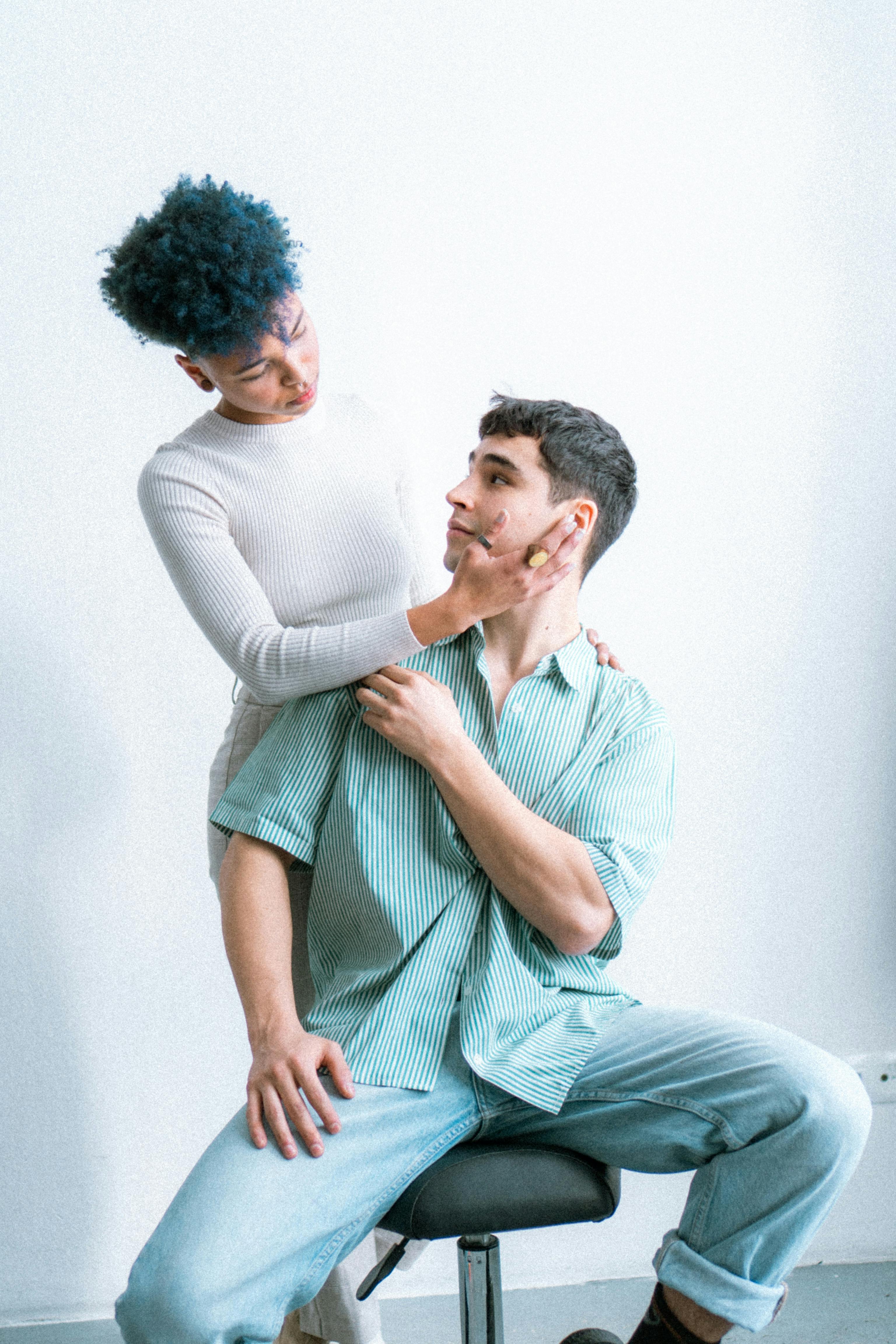 Woman Standing over Man Sitting in Shirt · Free Stock Photo