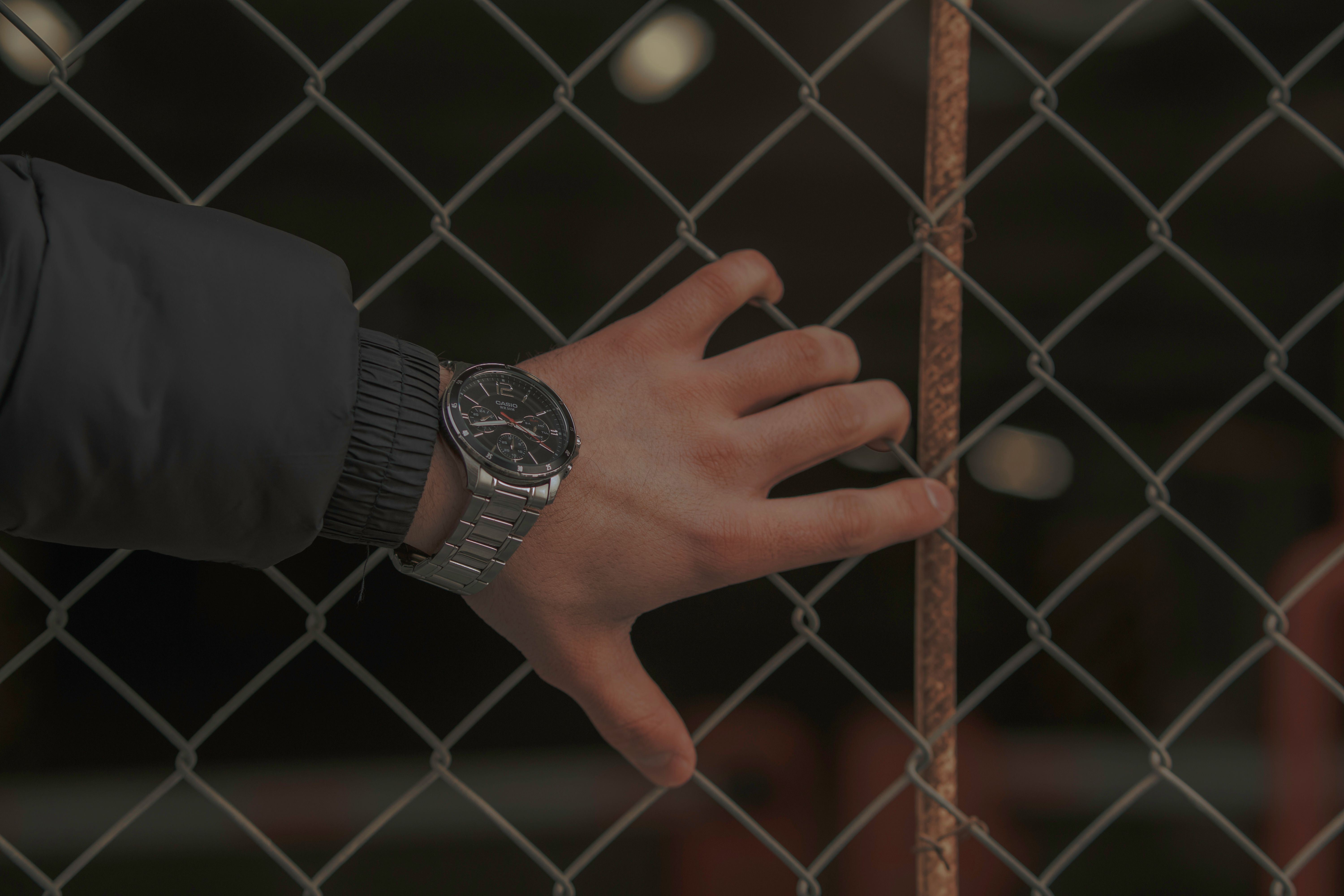 Man Hand Holding Fence Net · Free Stock Photo