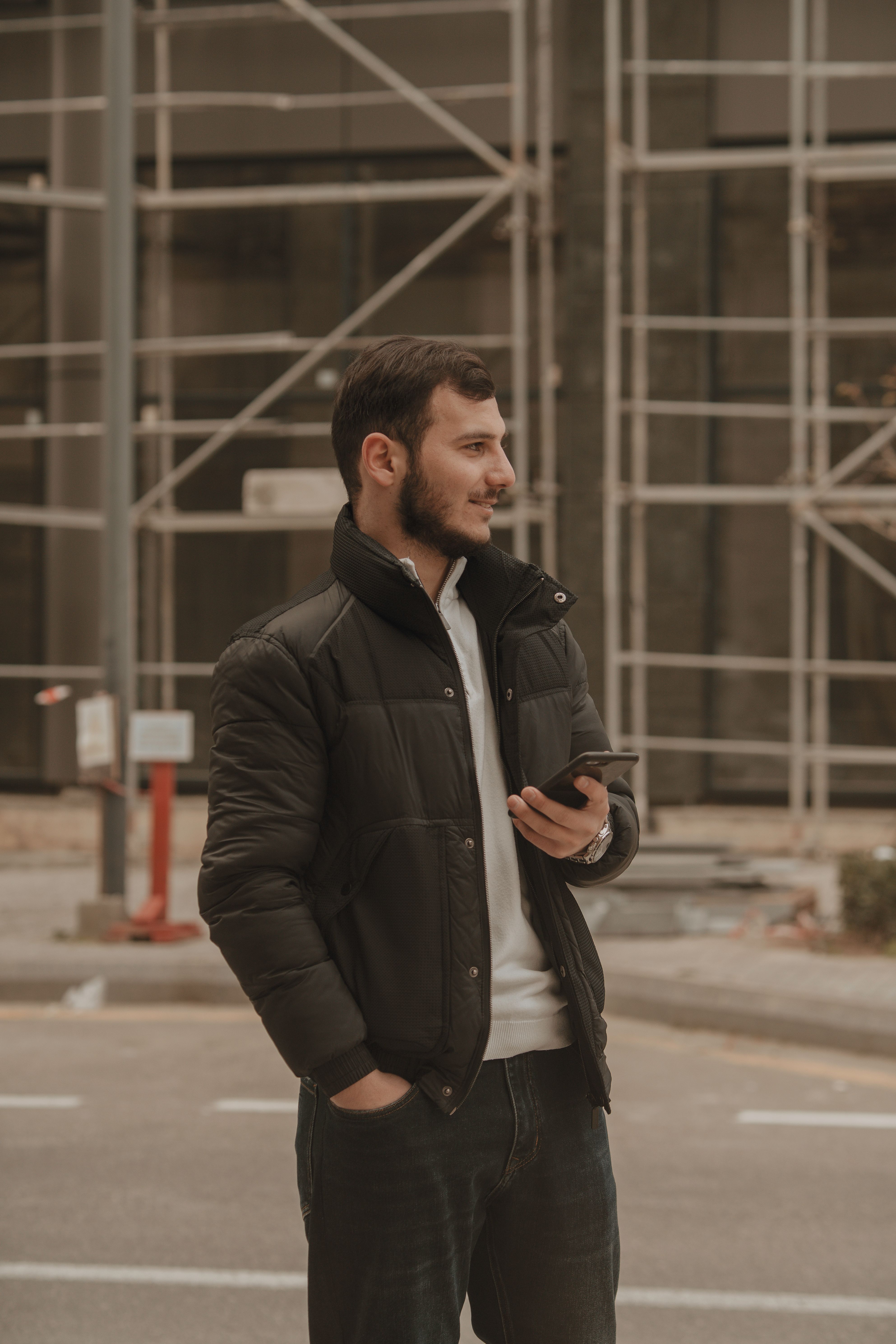 Man in Jacket Standing with Smartphone on Street · Free Stock Photo