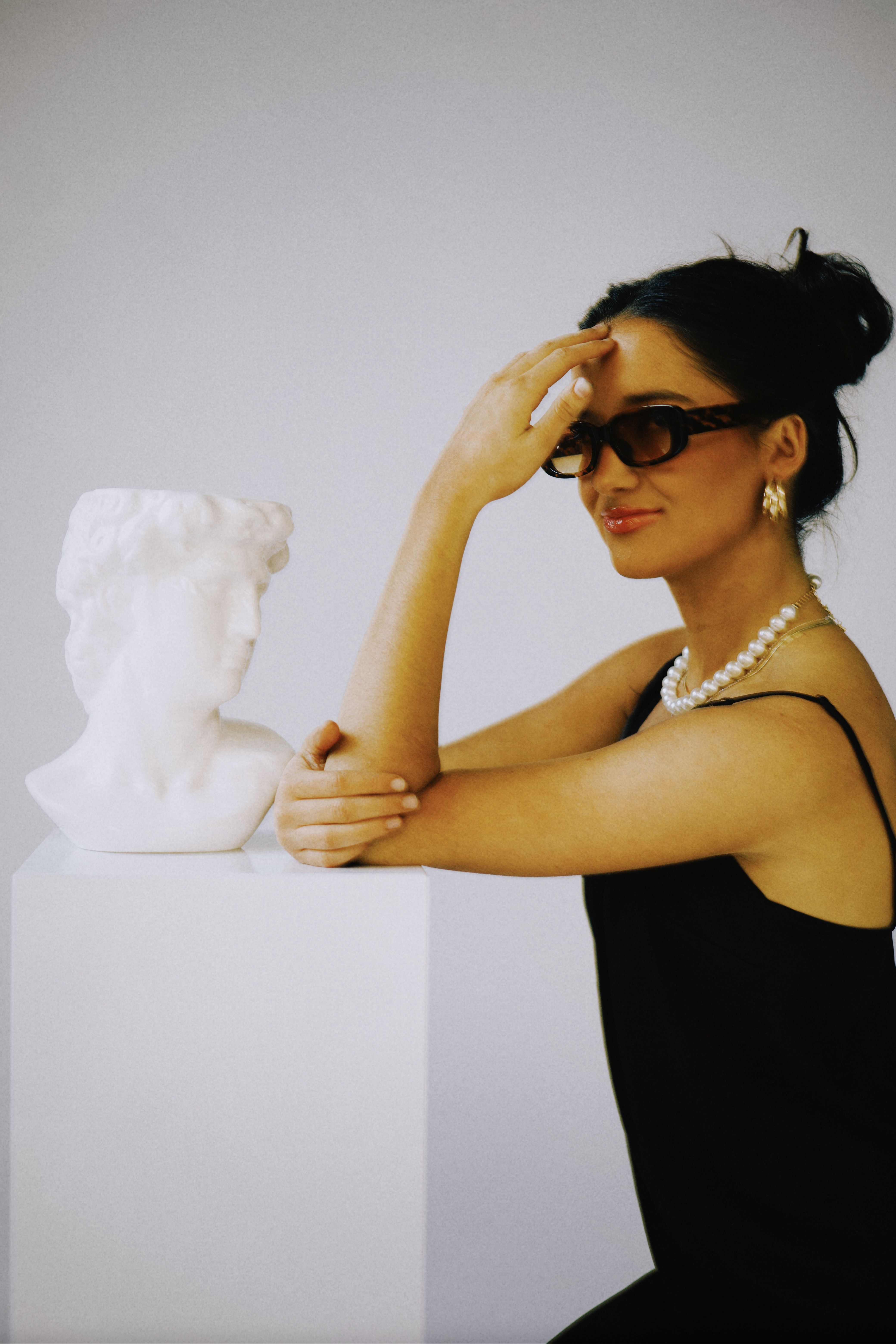Woman Resting her Elbow by the Sculpture · Free Stock Photo