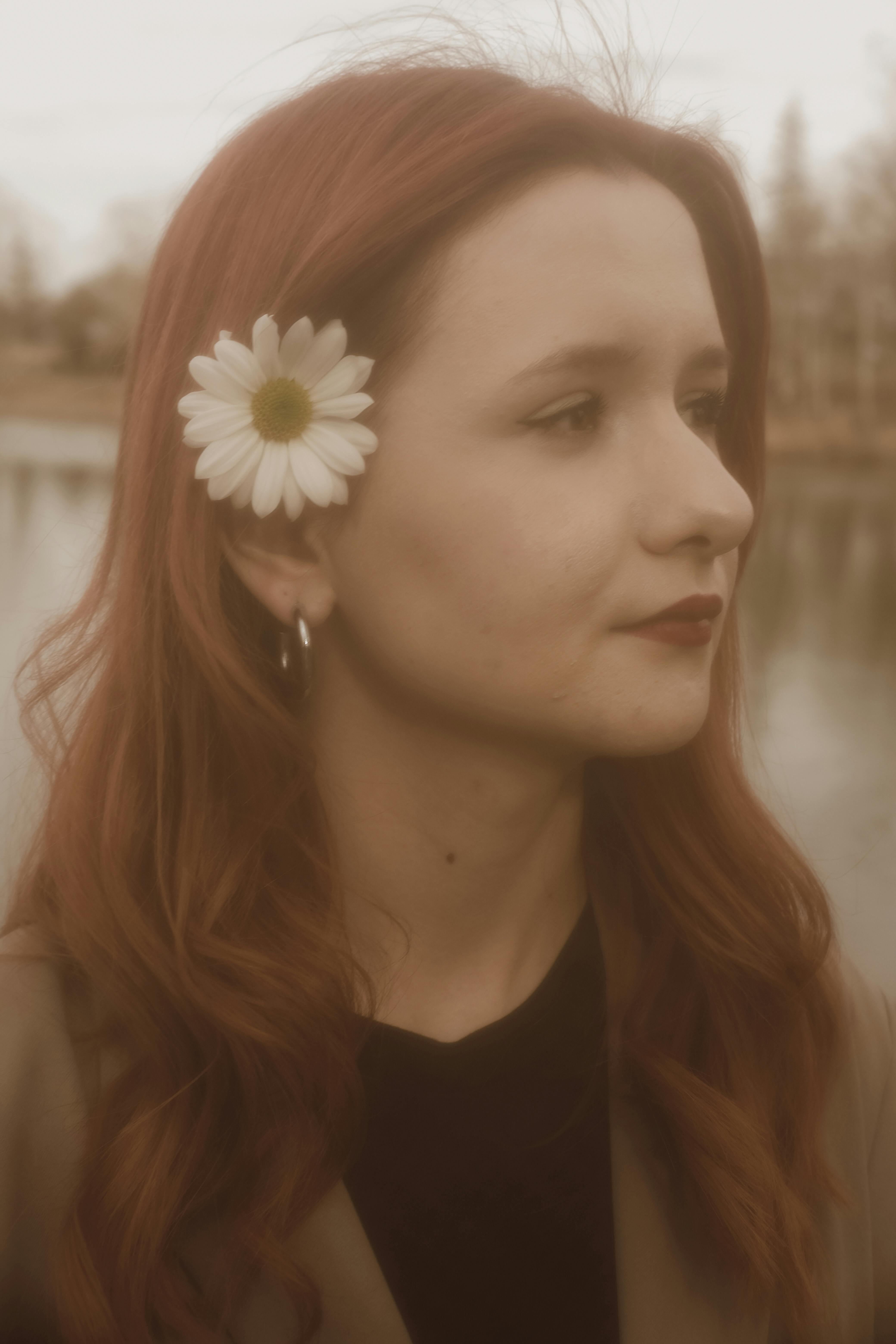 Portrait of a Woman with a Flower behind her Ear · Free Stock Photo