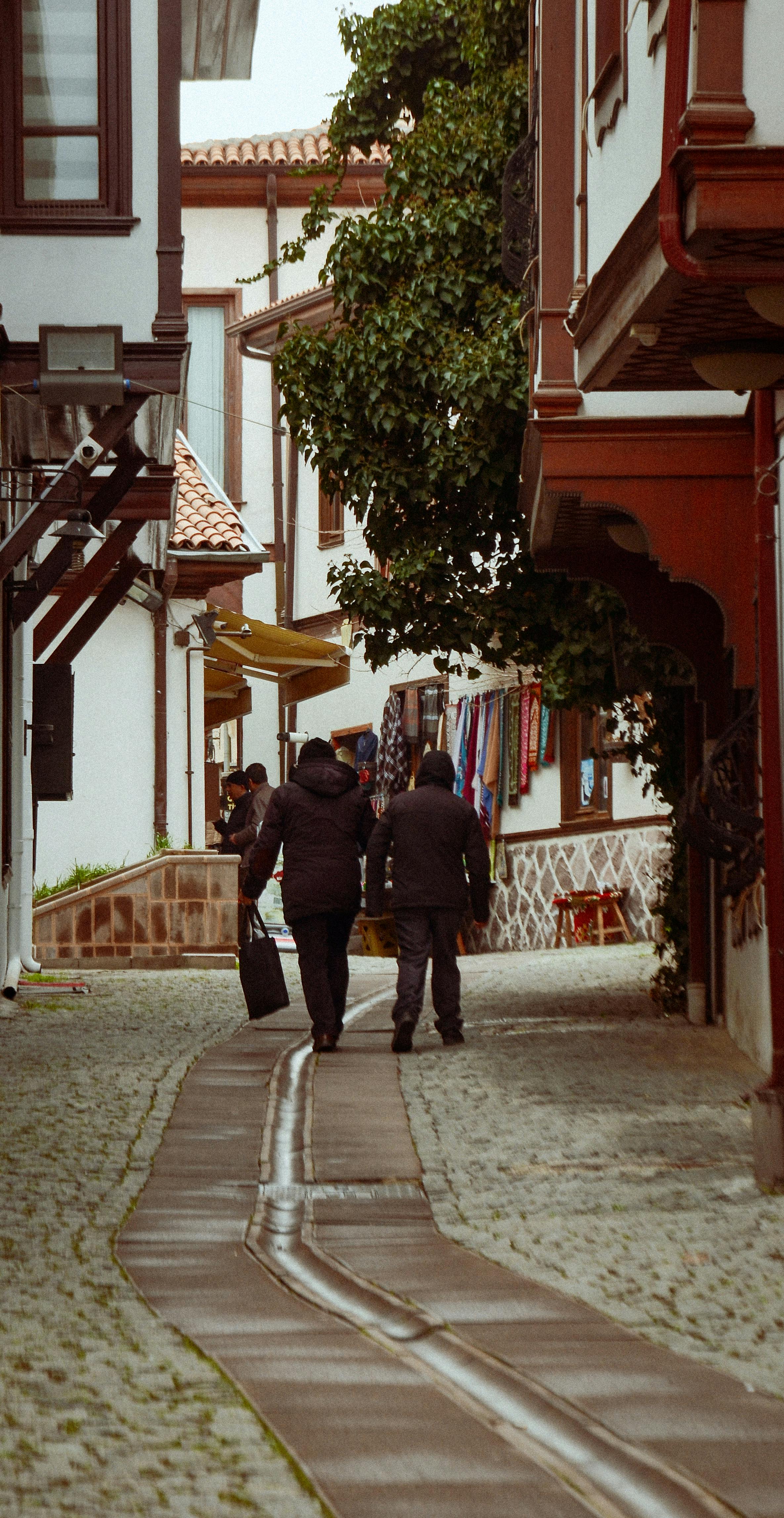 Back View of Pedestrians Walking between Houses in a Turkish City ...