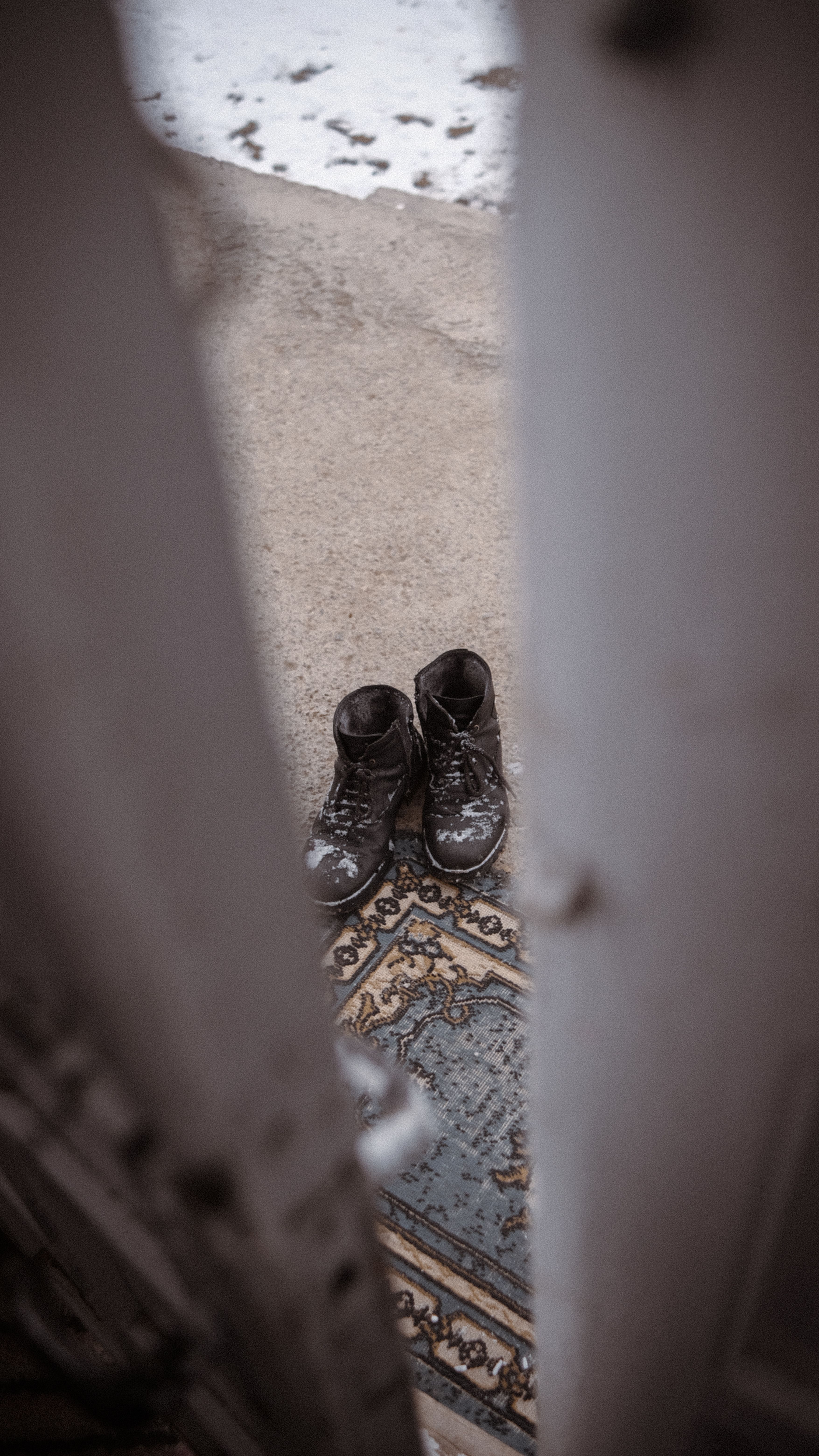 Shoes on Carpet behind Gap in Door · Free Stock Photo
