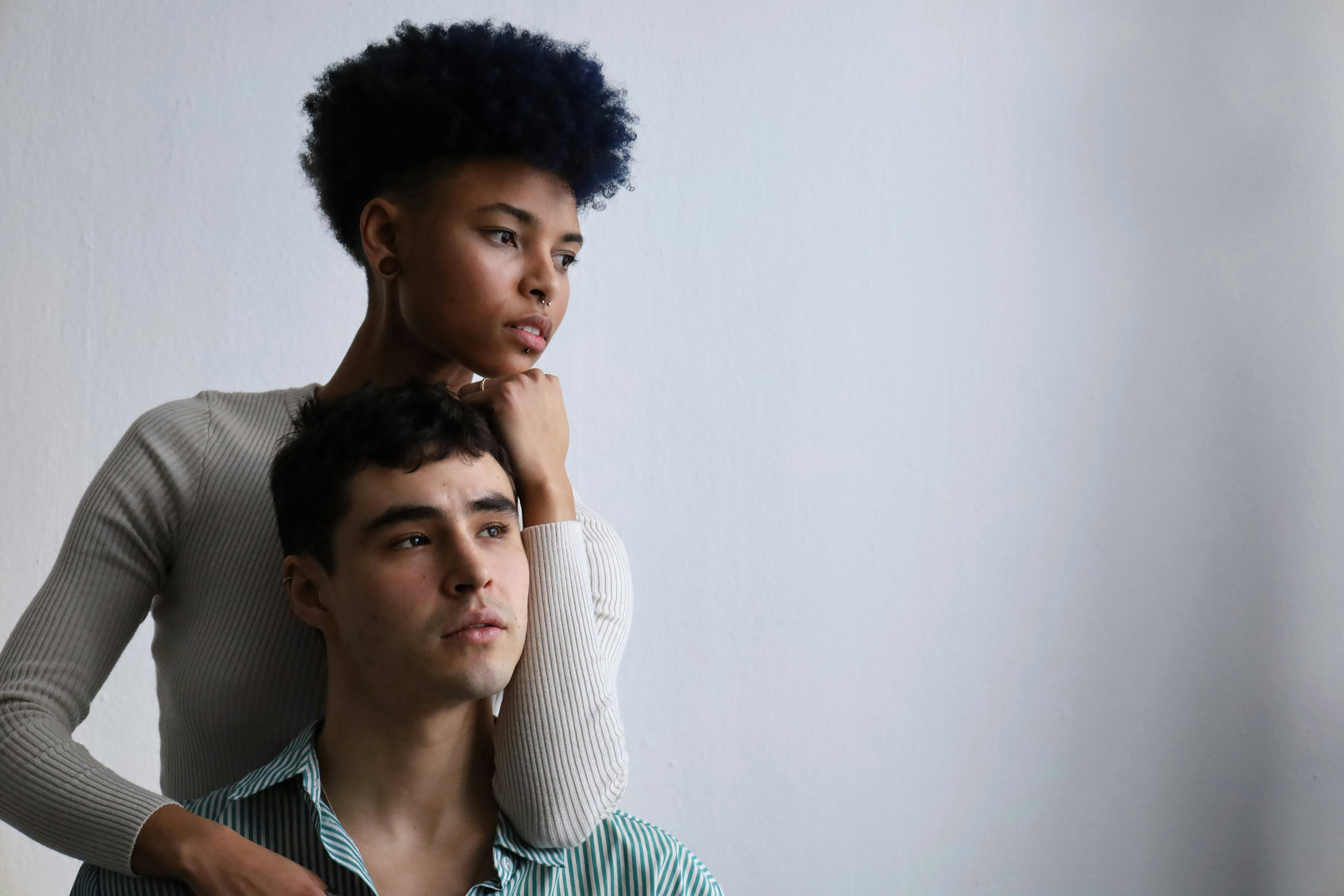 Woman with Hand on Chin Standing over Man · Free Stock Photo