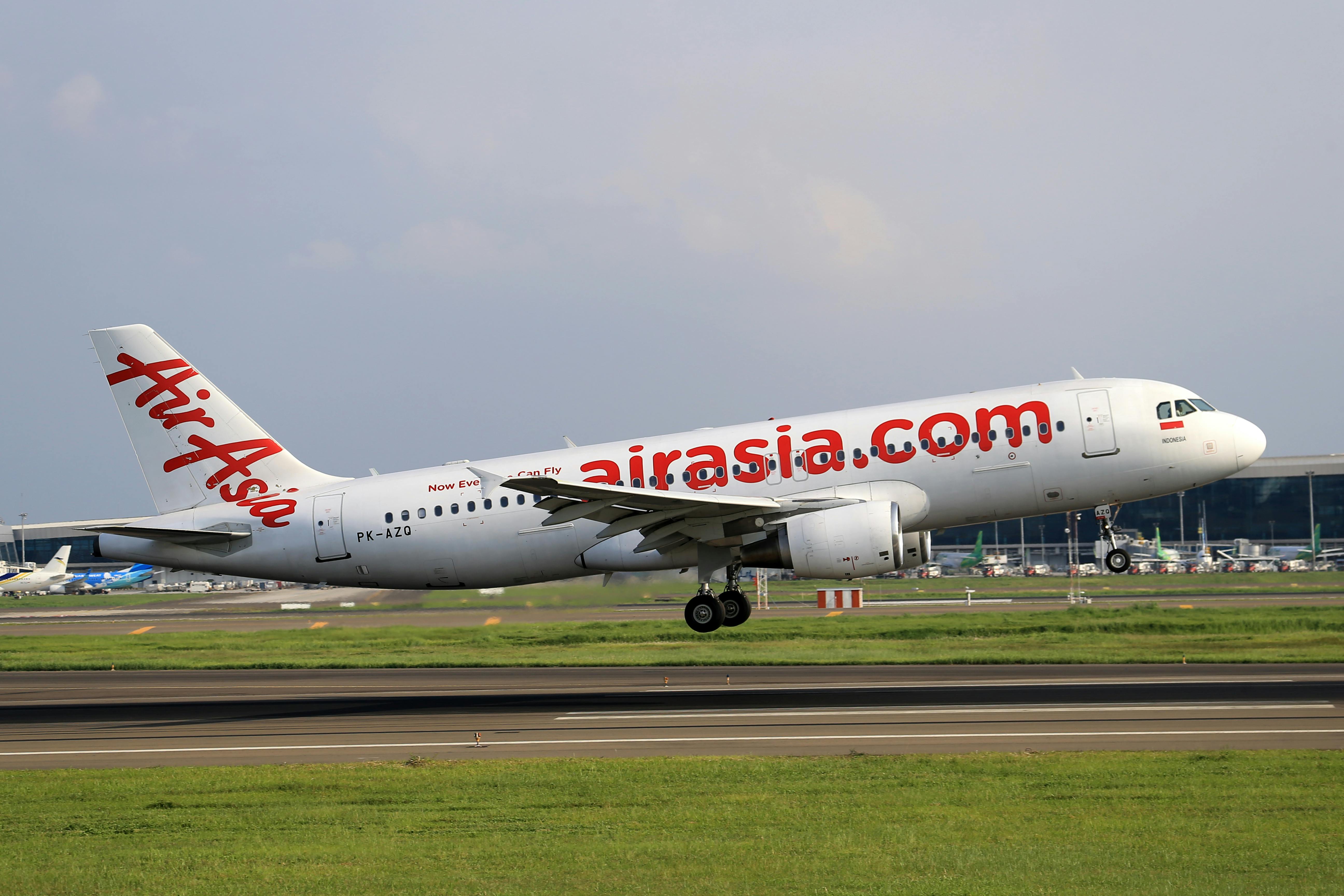 An airasia plane taking off from an airport runway · Free Stock Photo