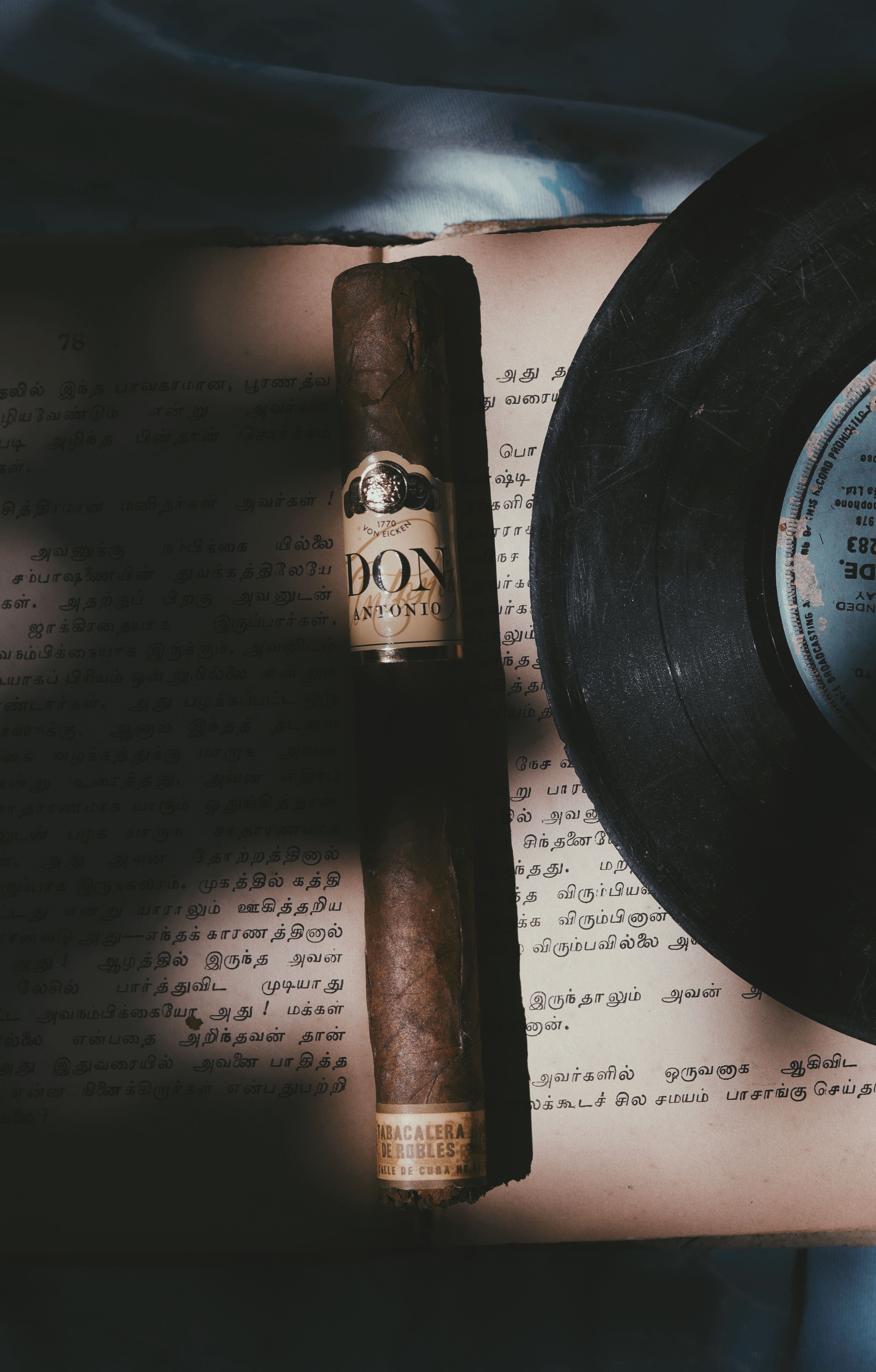 Cigar and Vinyl Disk on Book · Free Stock Photo