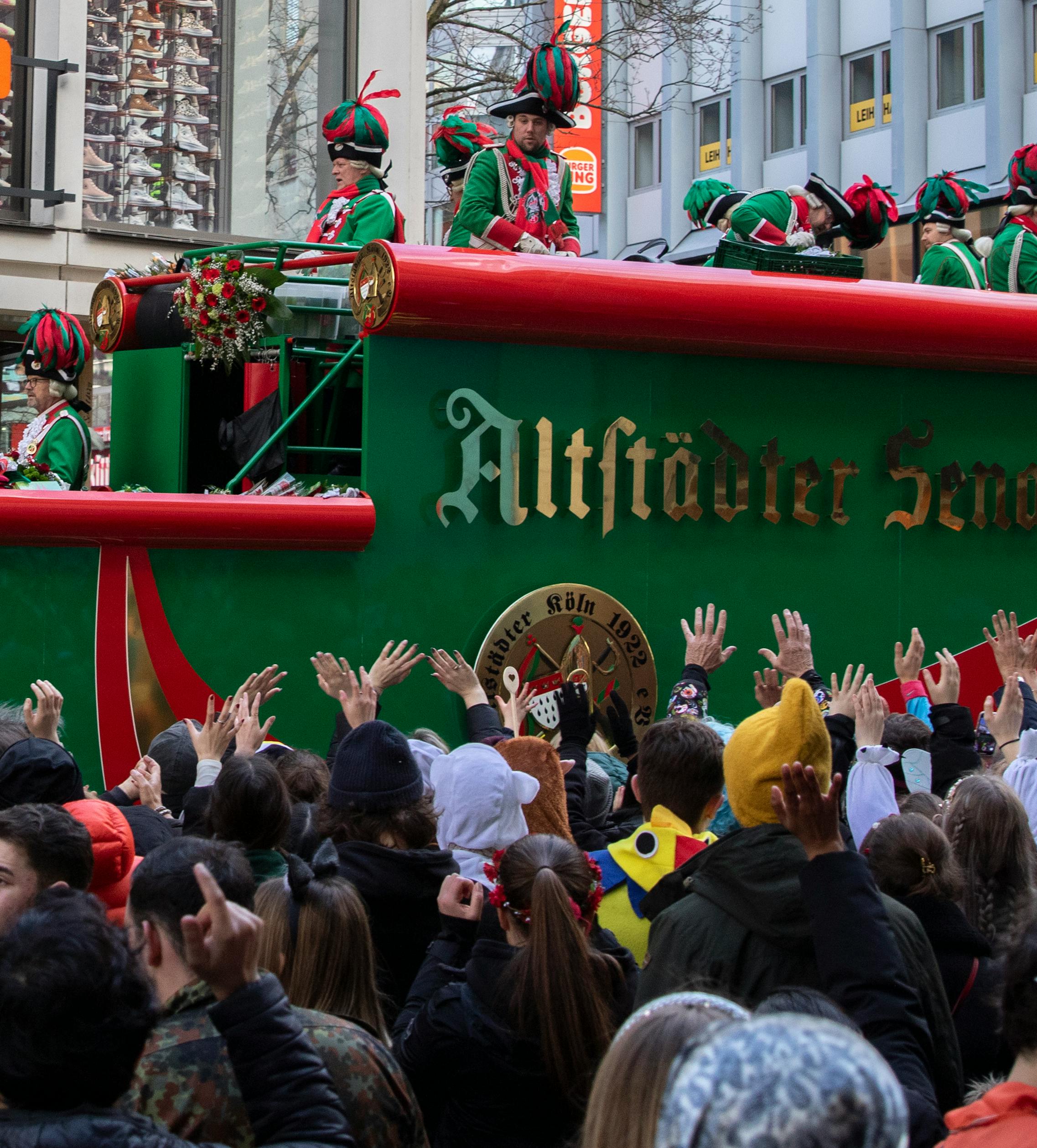 A parade float with people waving and waving · Free Stock Photo