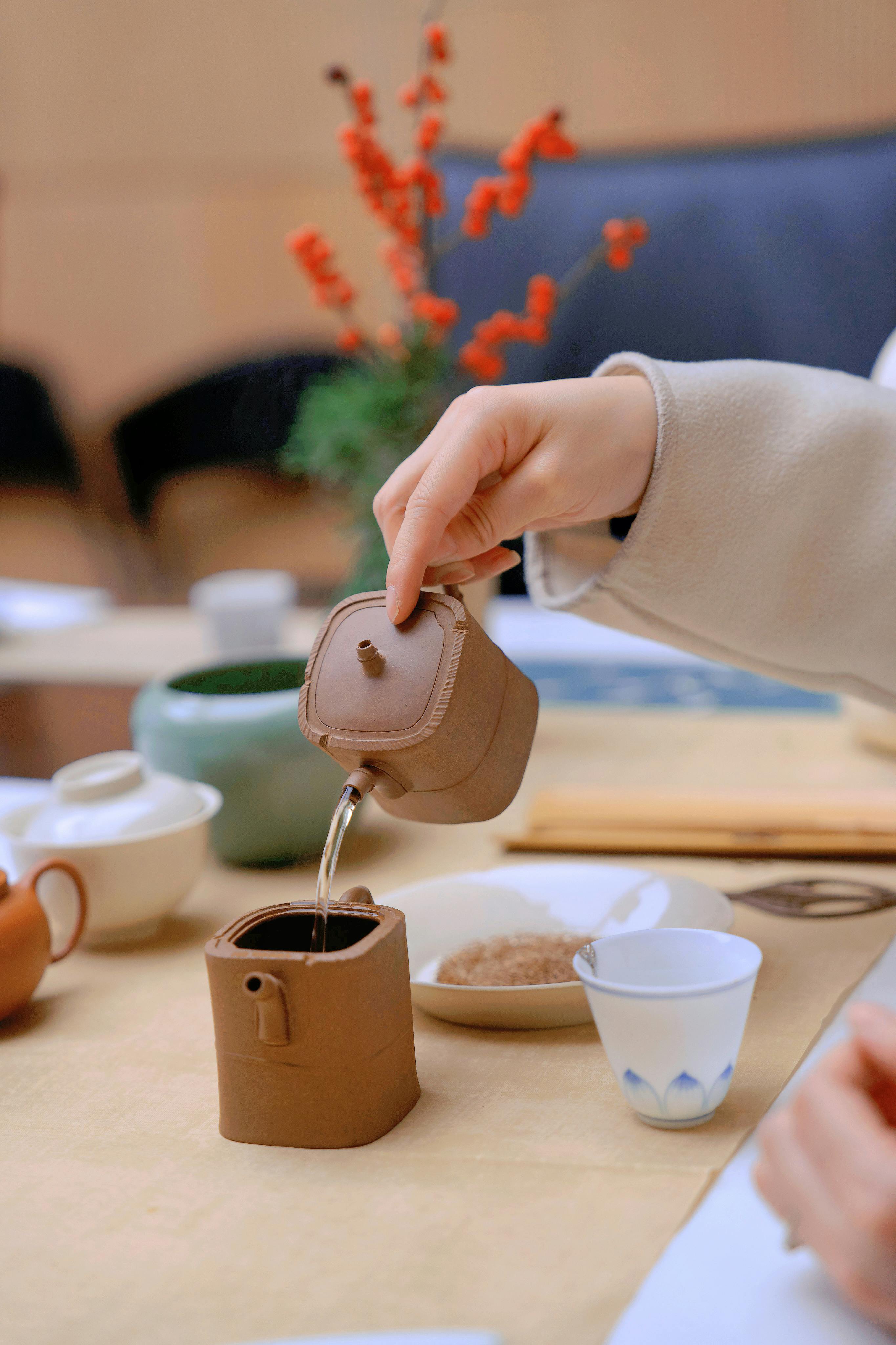 Close-up of Woman Pouring Water from a Clay Pot · Free Stock Photo