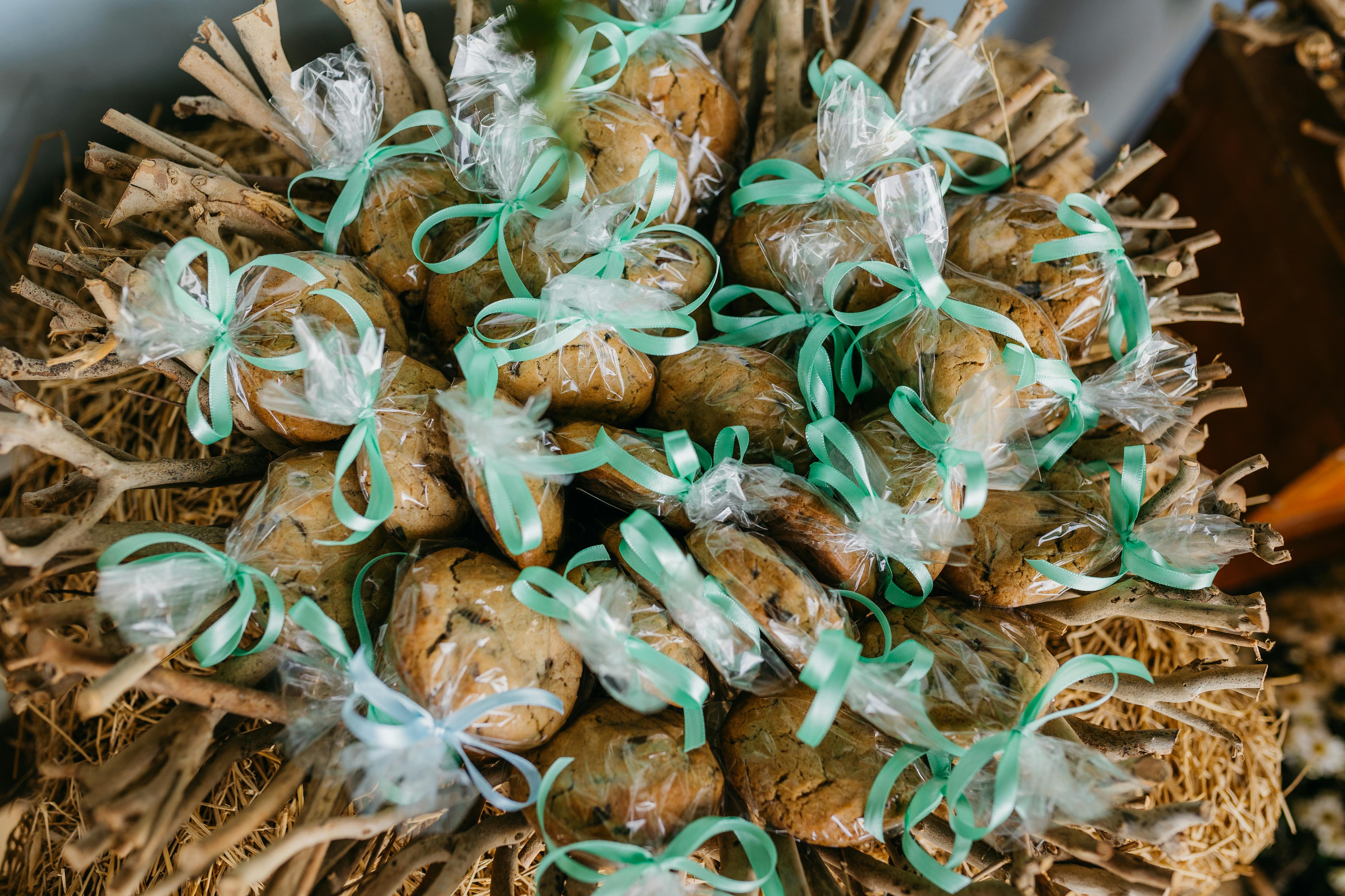 Small Packets of Cookies Decorated with Green Ribbon · Free Stock Photo