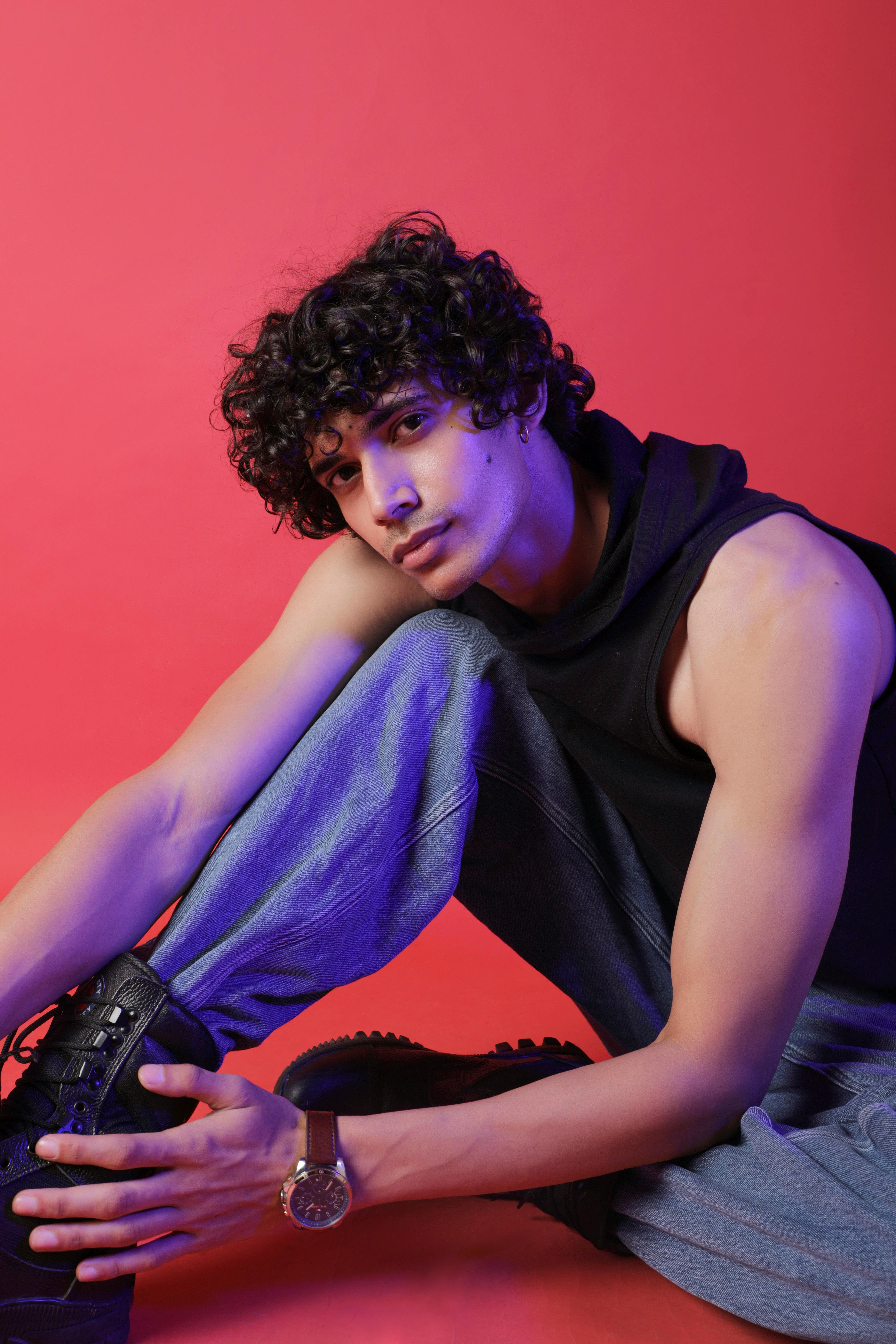 Man Sitting on Red Background · Free Stock Photo