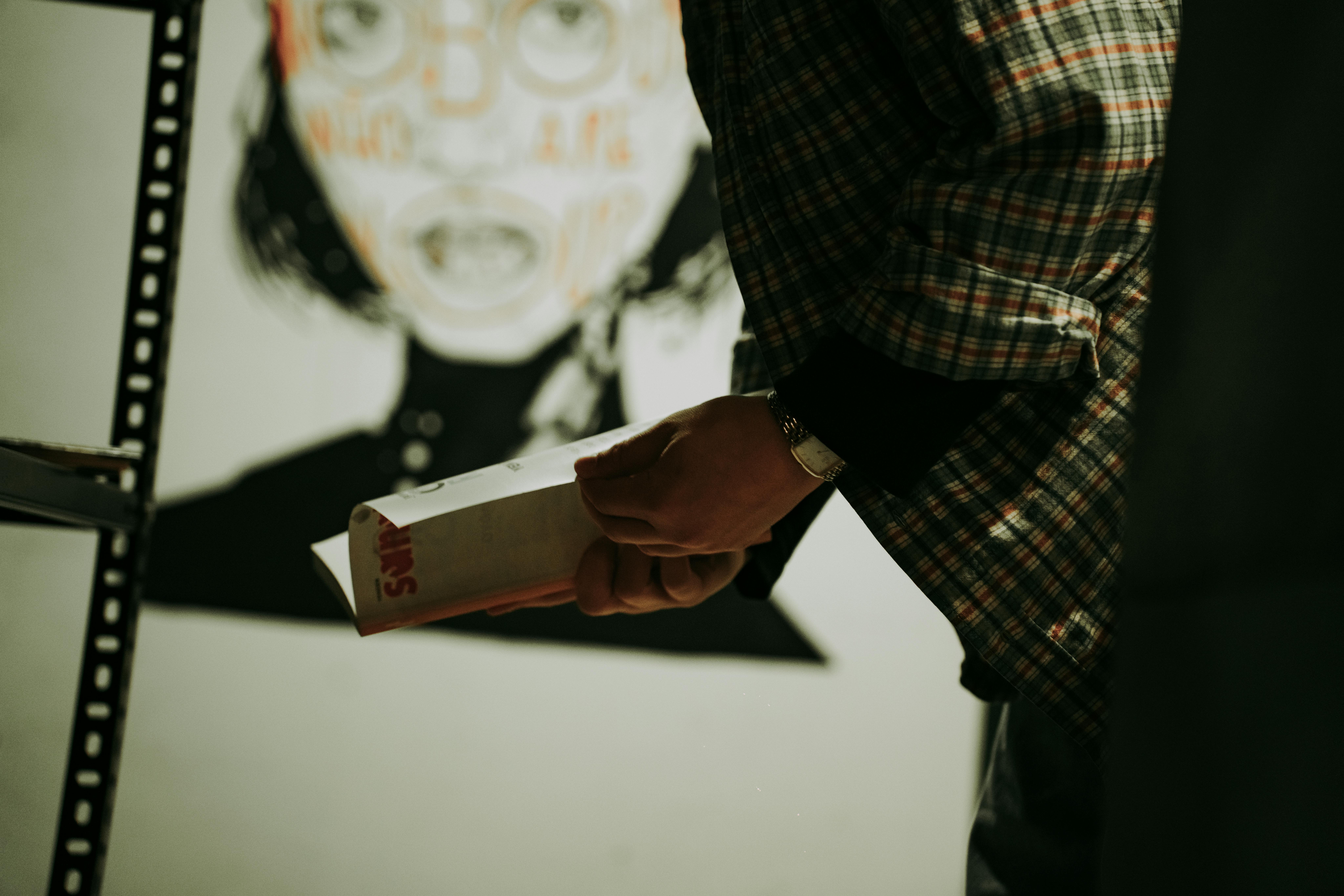 Hands of a Person Browsing a Magazine · Free Stock Photo