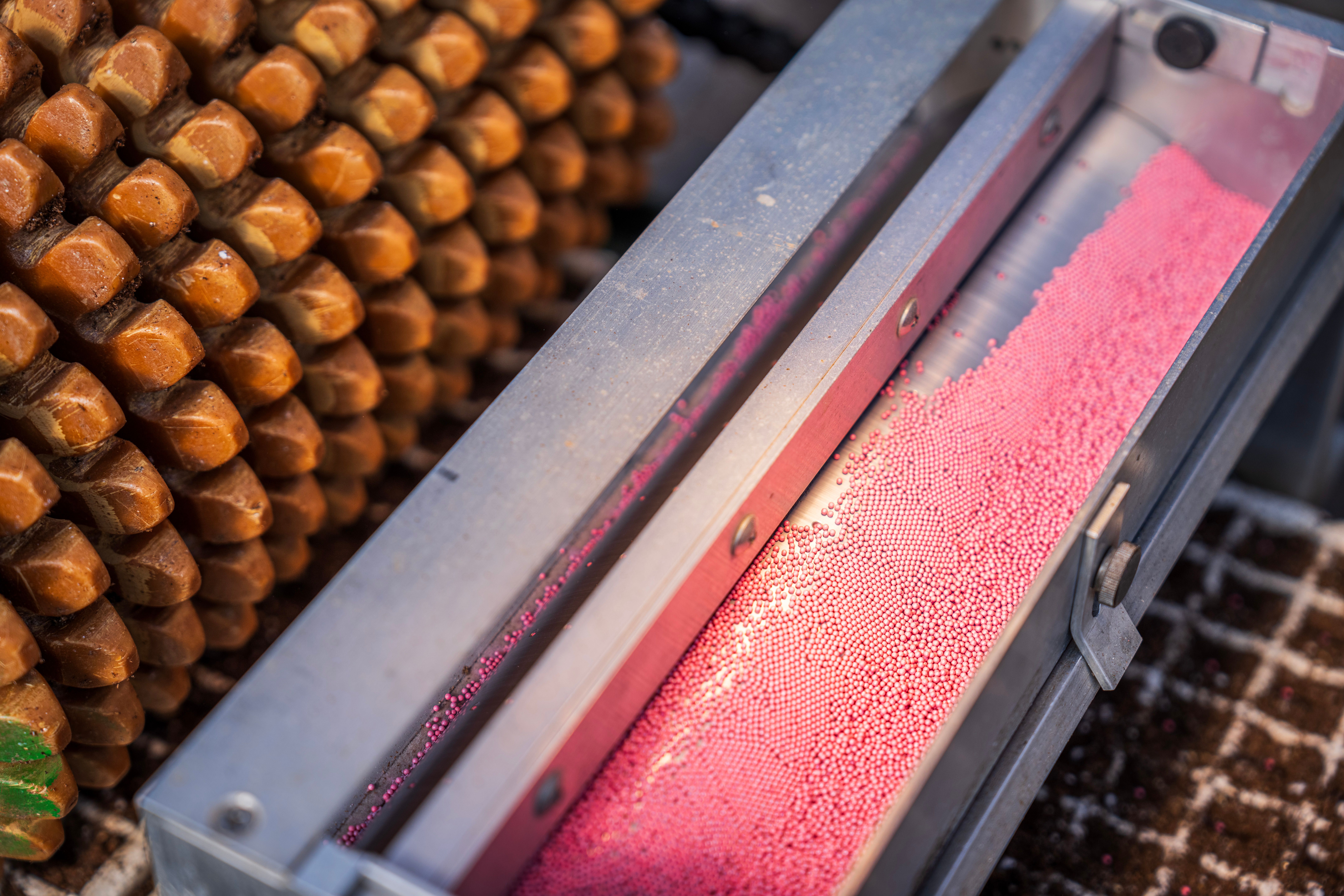 A machine that is making a pink substance · Free Stock Photo