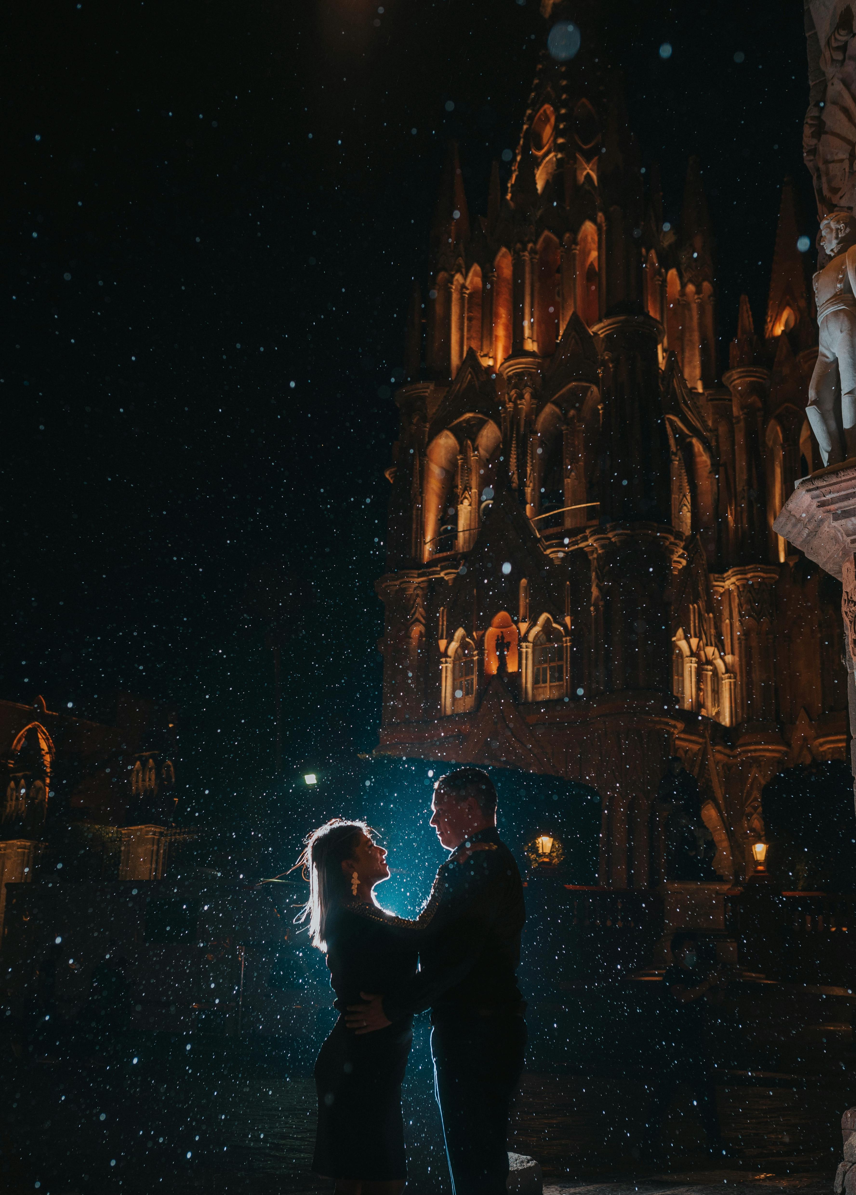 Couple in Front of a Church at Night · Free Stock Photo