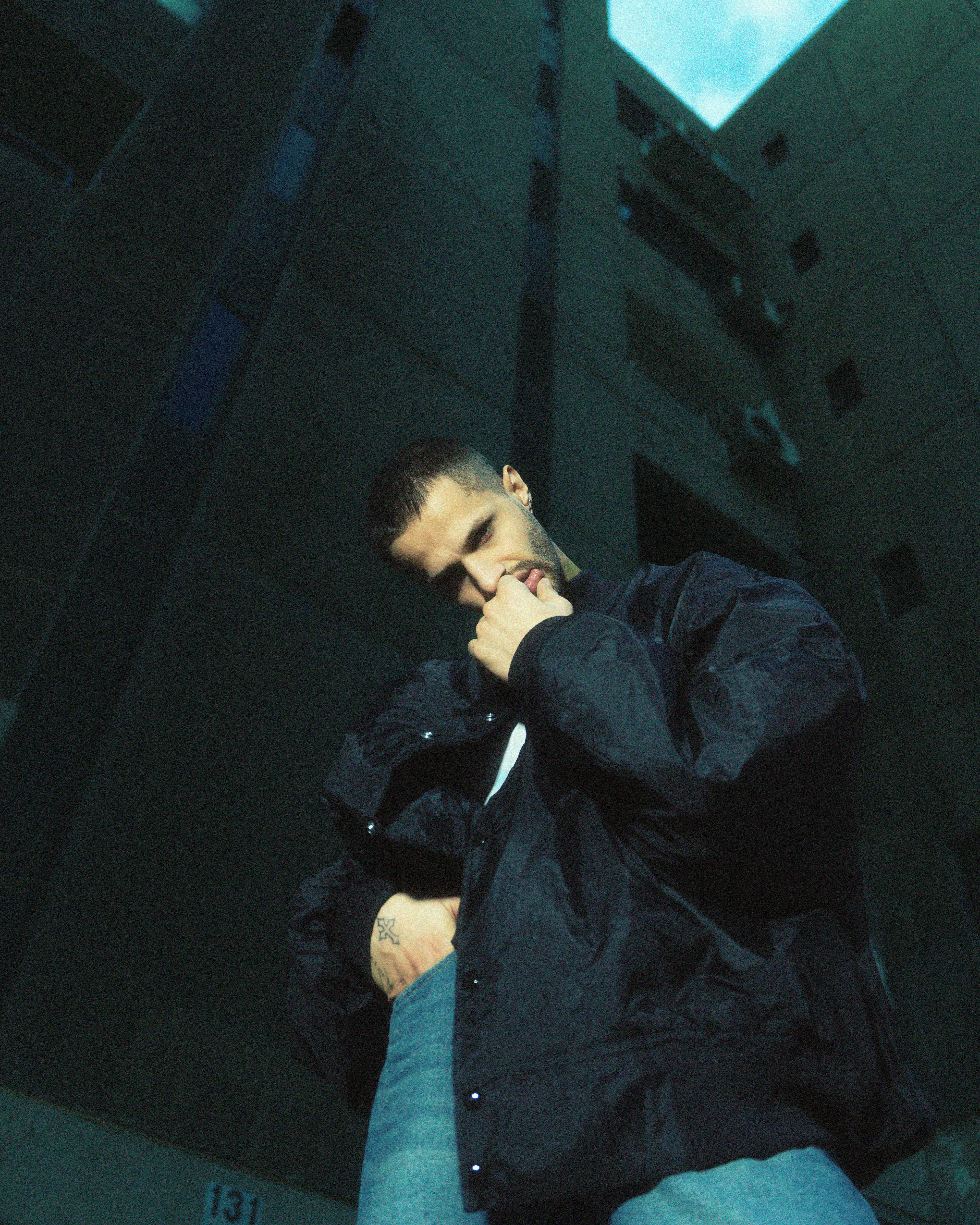 Low Angle Shot of a Man in a Casual Outfit Posing in Front of a ...