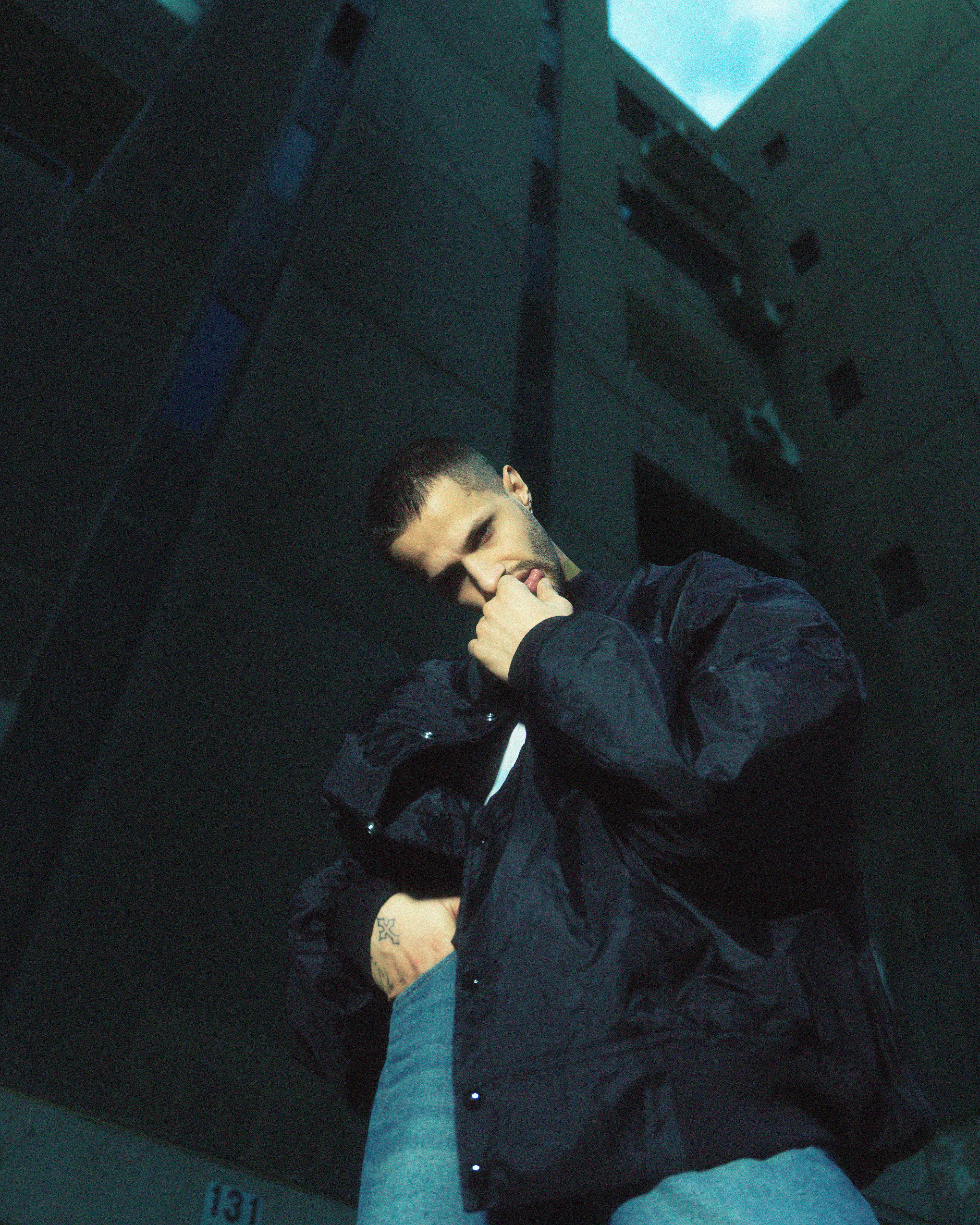 Low Angle Shot of a Man in a Casual Outfit Posing in Front of a ...