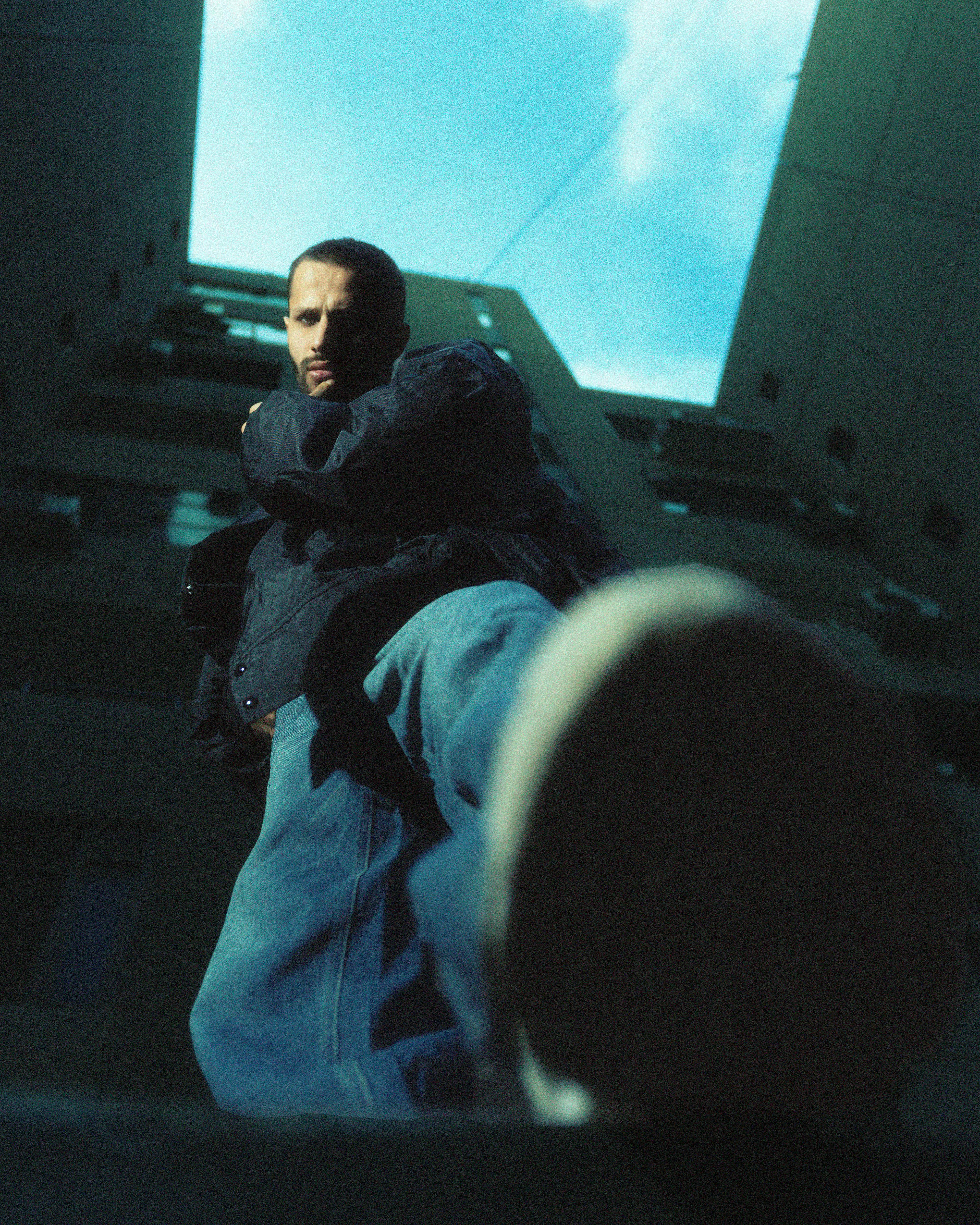 Man in Black Jacket Standing over Camera · Free Stock Photo