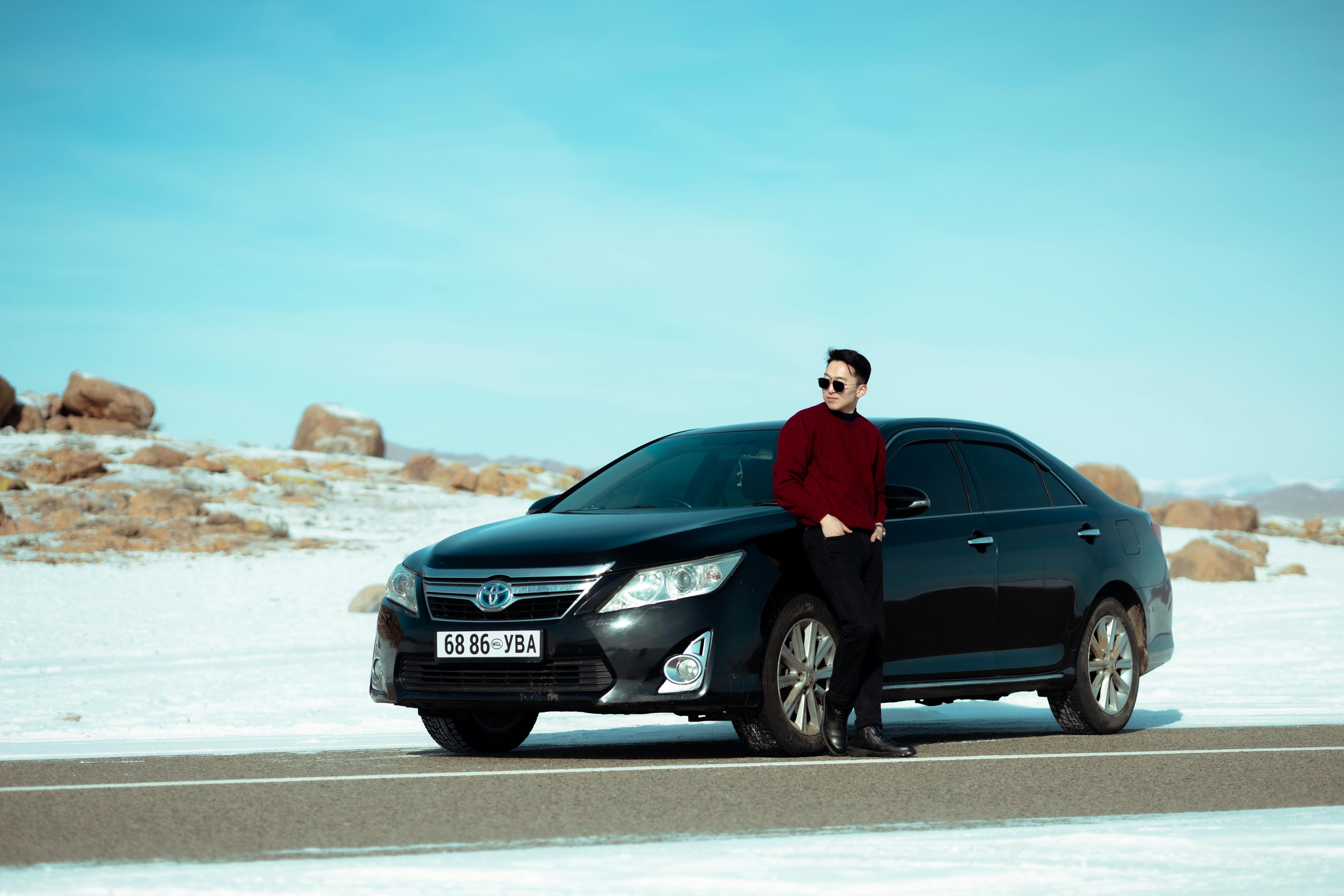Man in Front of Black Toyota on a Desert · Free Stock Photo