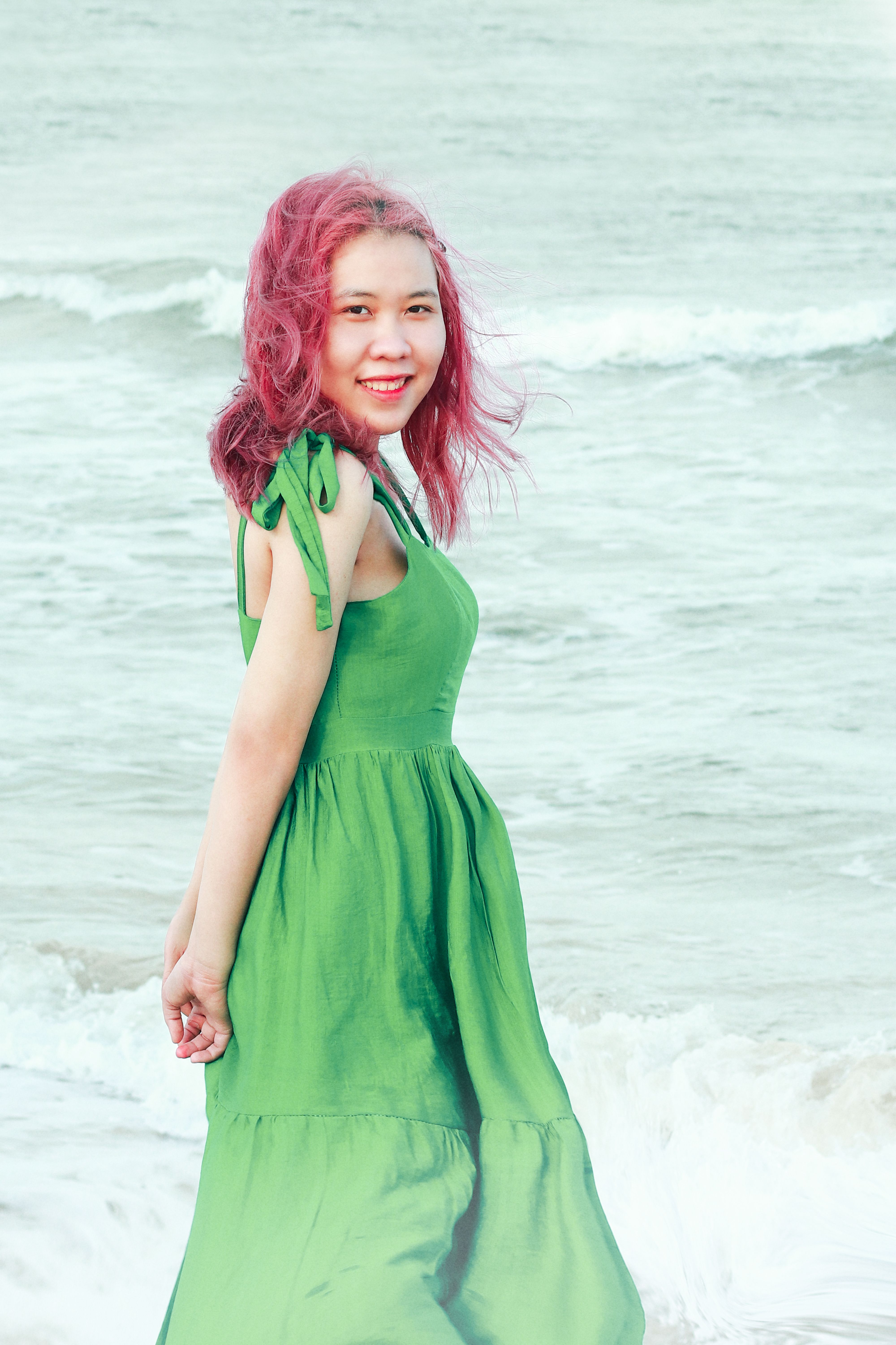 Female Model Wearing a Green Dress Standing on a Seashore · Free Stock ...