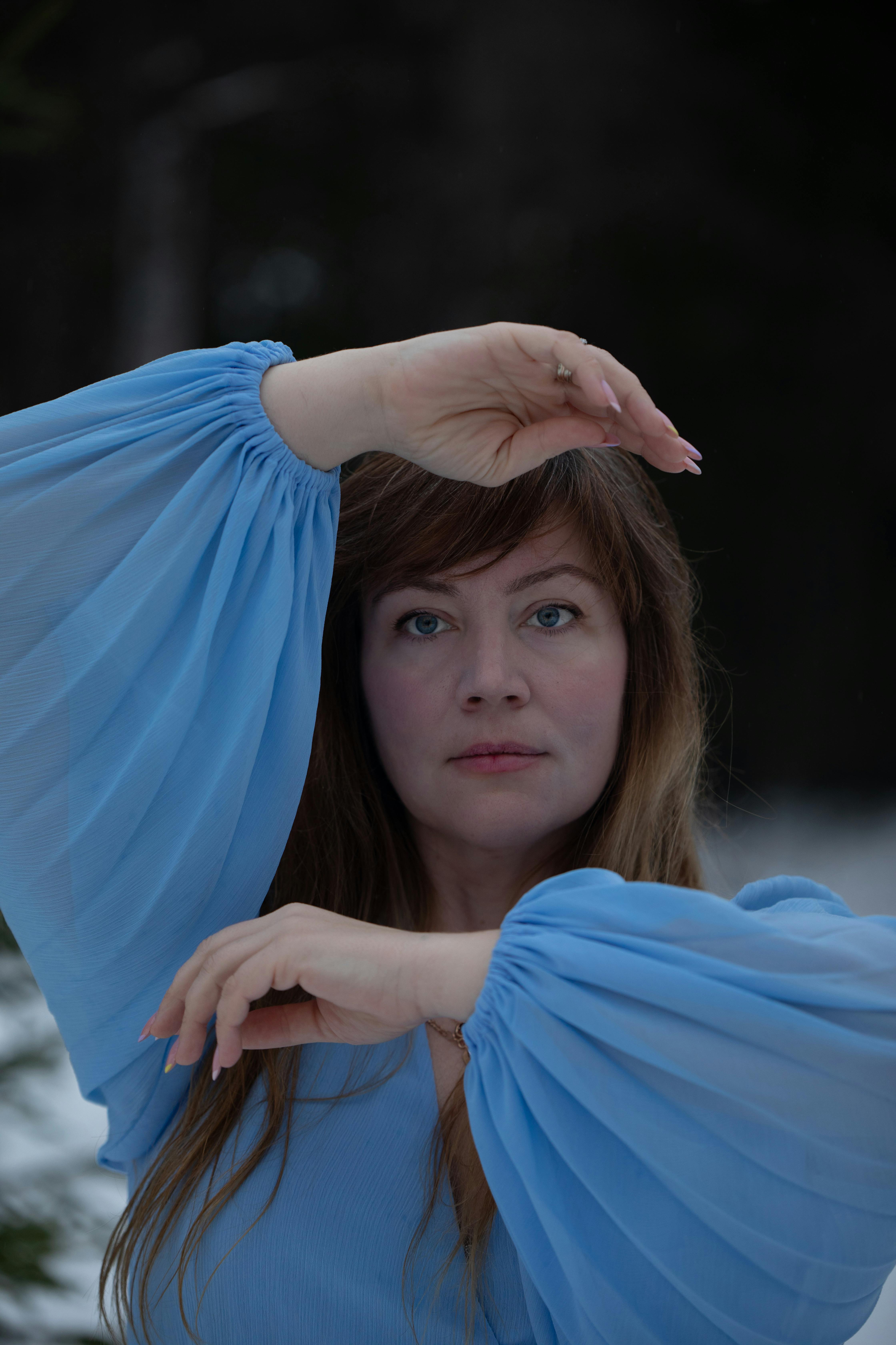 Woman in Blue Dress Standing with Hands around Face · Free Stock Photo