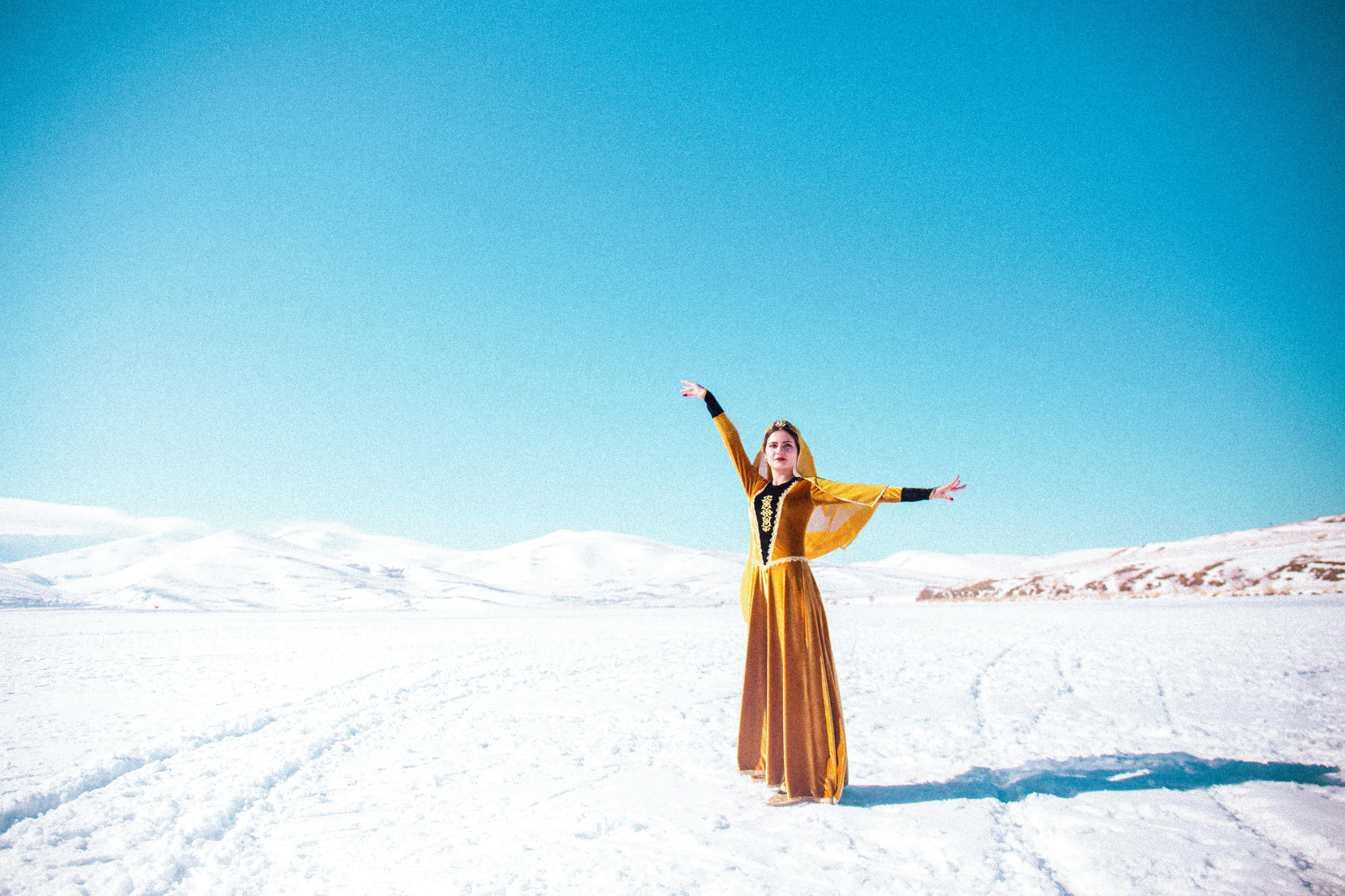 Woman in Yellow Dress Posing in Snow · Free Stock Photo