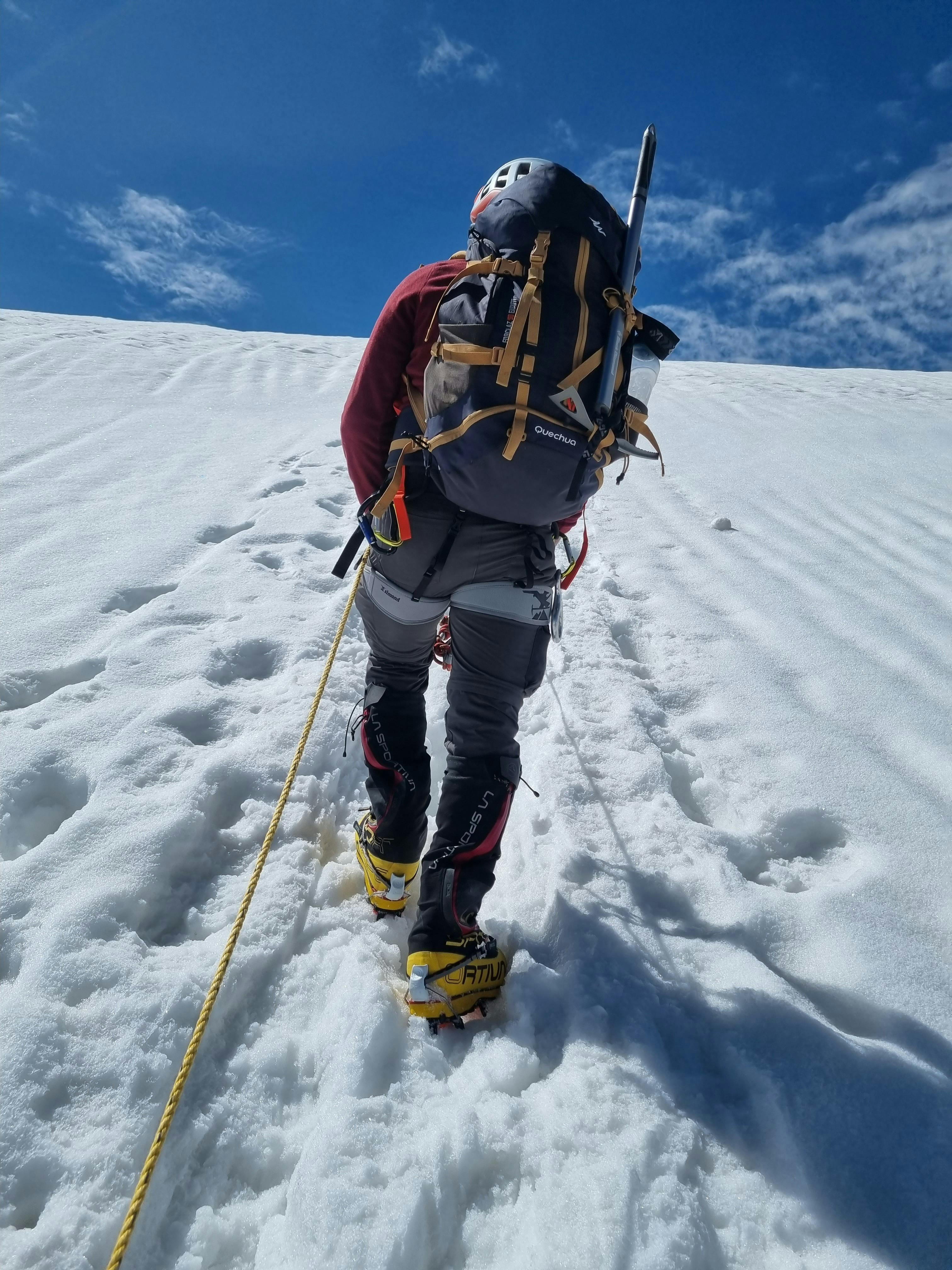 Back View of Person Climbing Mountain · Free Stock Photo
