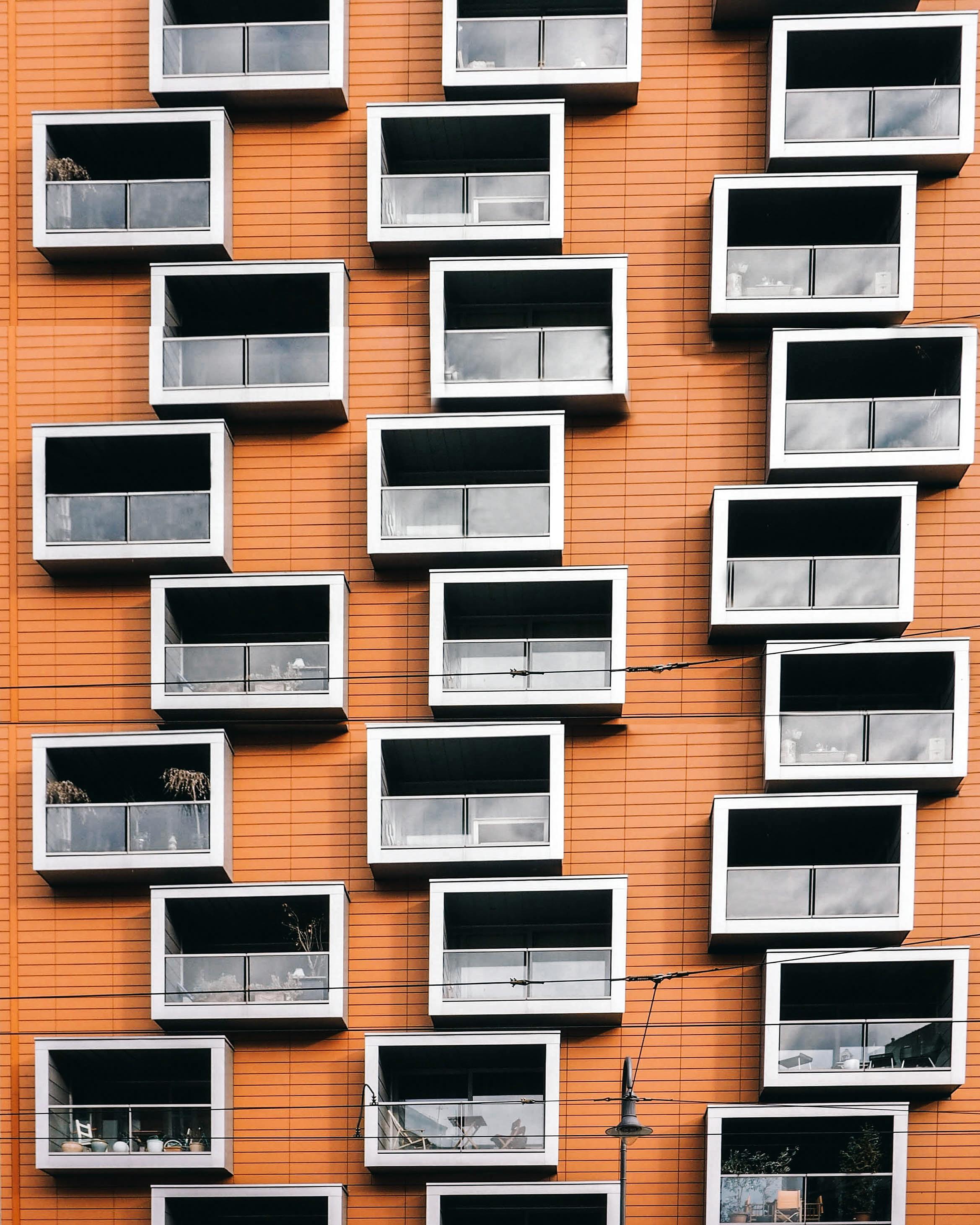 Red Facade of an Apartment Building with Asymmetrically Arranged ...